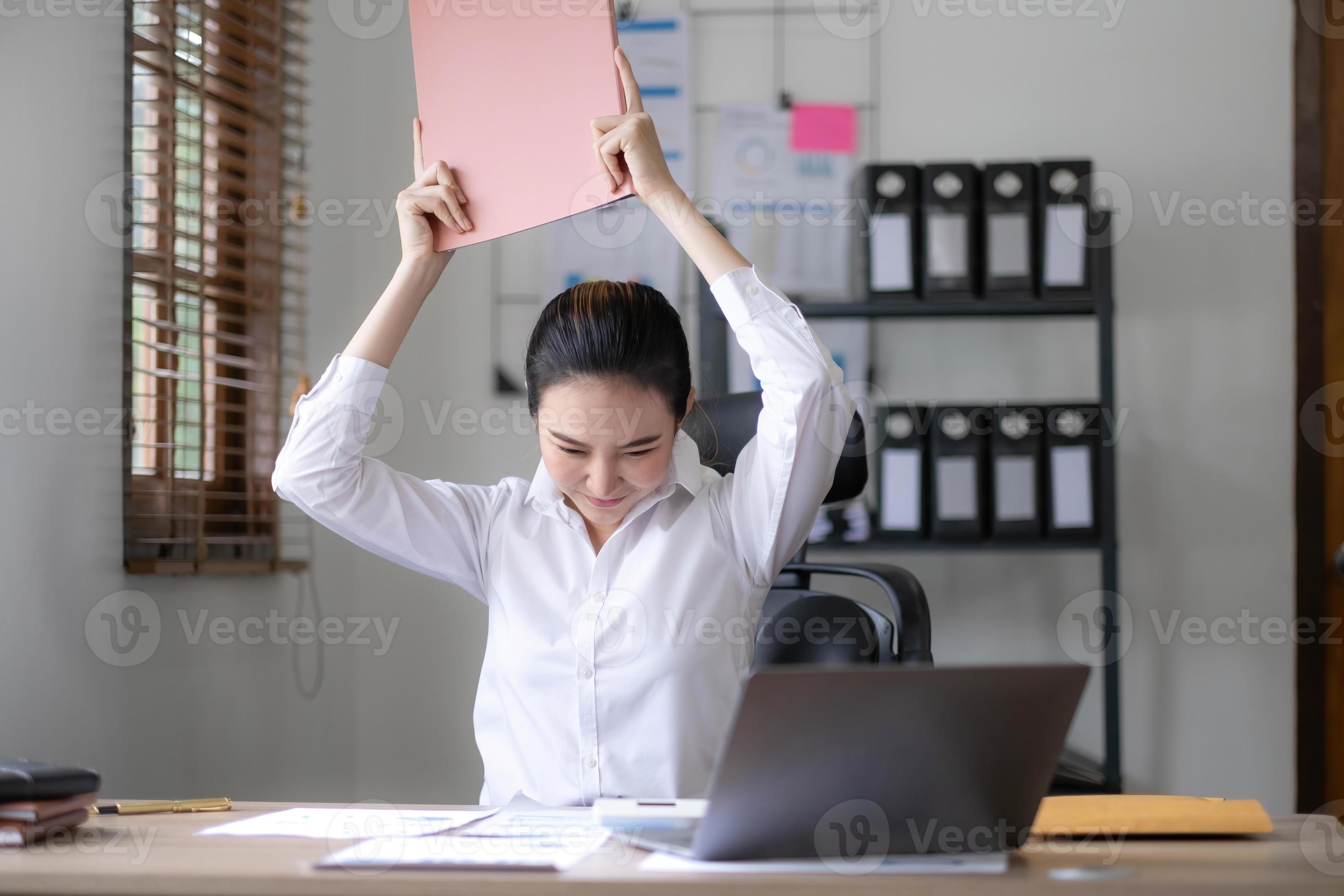Serious asian businesswoman analyzing financial graph at her workplace ... Serious asian businesswoman analyzing financial graph at her workplace ...