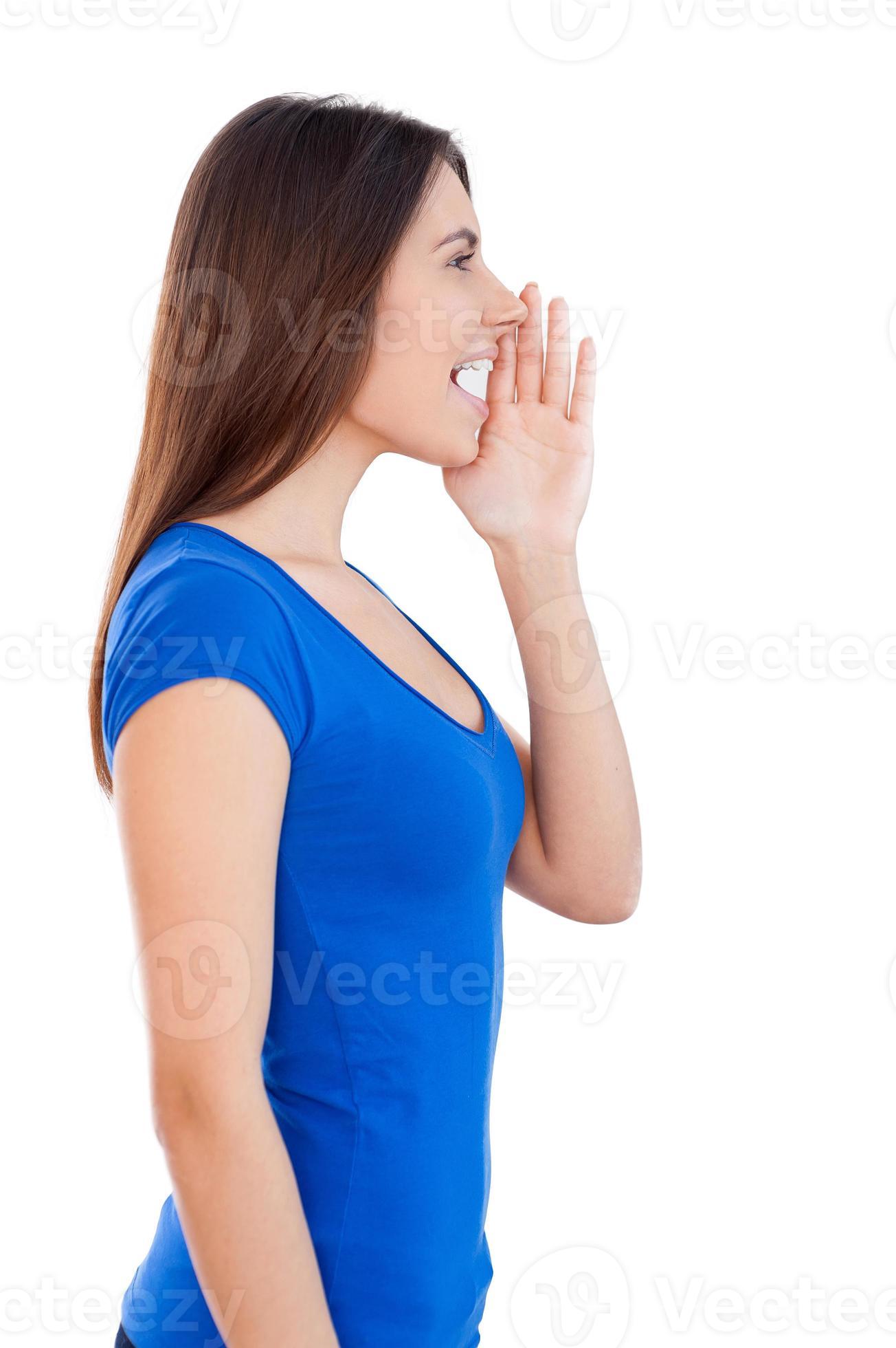 Woman shouting. Side view of beautiful young woman shouting and holding ...