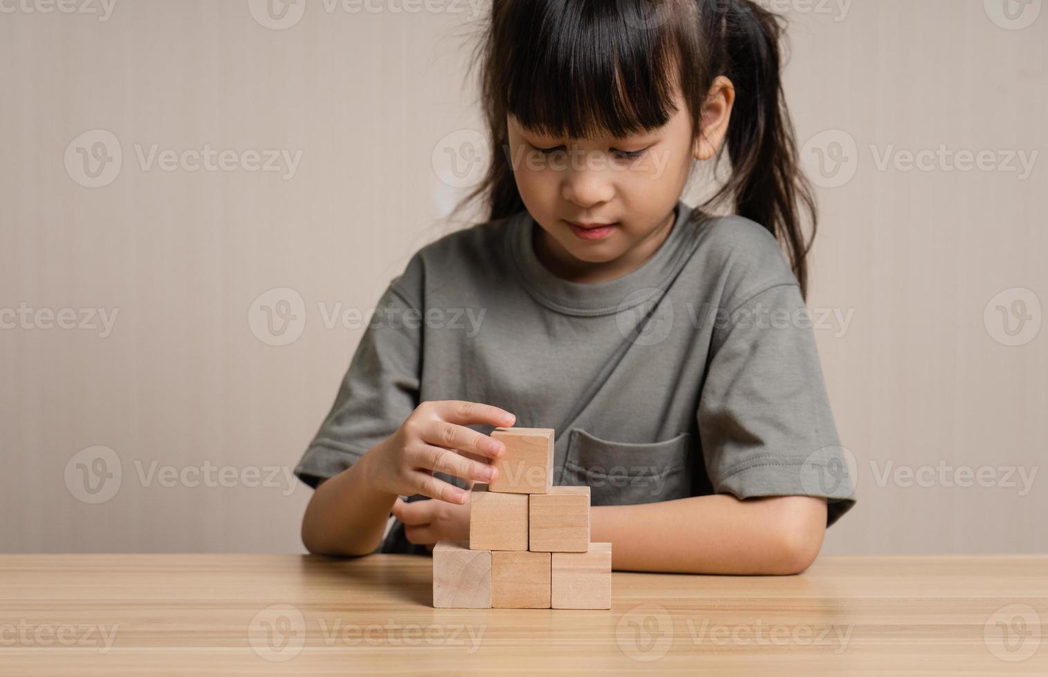 Girls Build Wooden Cubes In Layers With Wooden Blocks Cube Wooden Box Girl Playing With Wooden