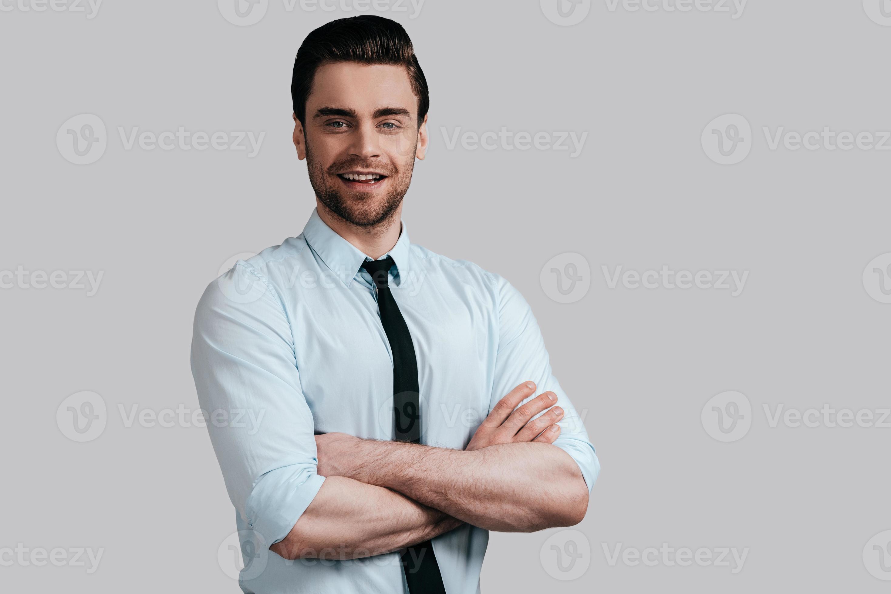 Confidence and charisma. Handsome young smiling man in white shirt and ...