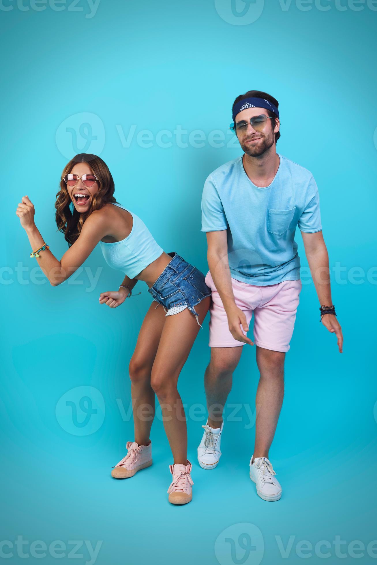 Full Length Of Beautiful Young Couple Having Fun While Standing Against