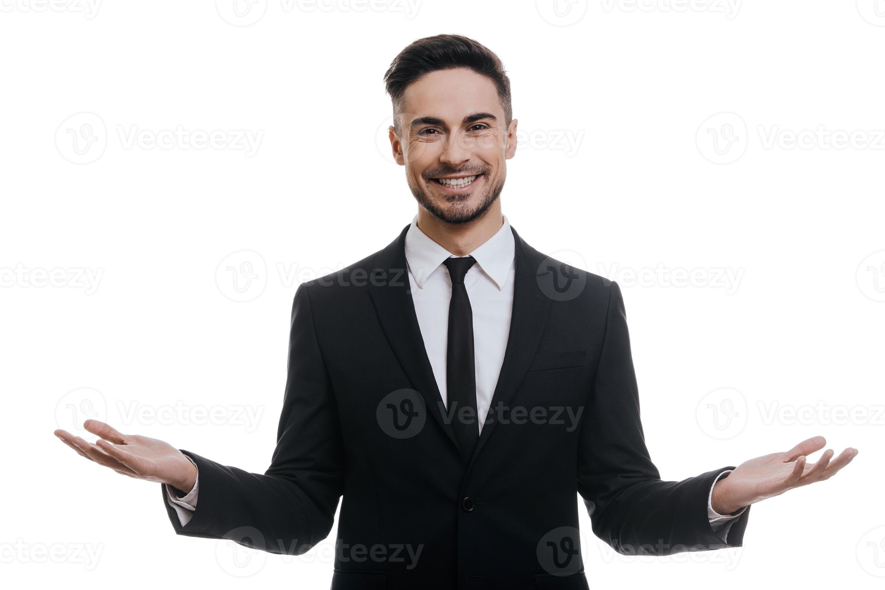 Welcome Handsome young man in full suit looking at camera and keeping ...