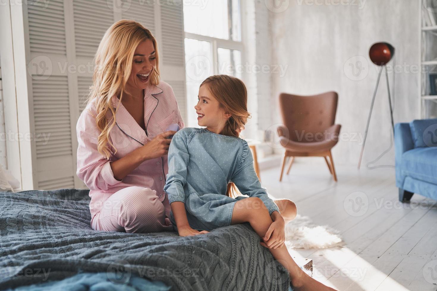 Taking Good Care Of Her Beautiful Young Mother Brushing Her Daughters