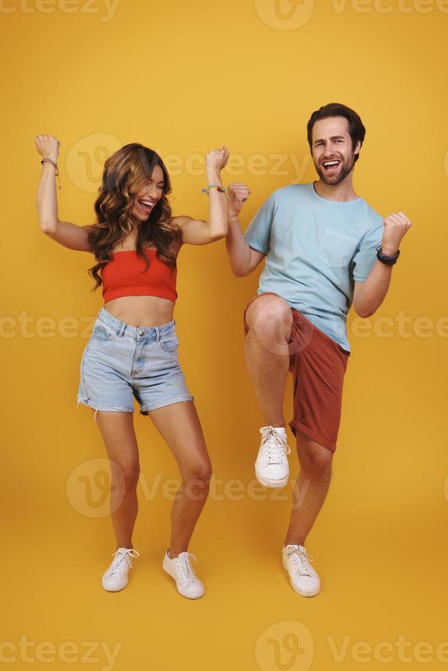 Full Length Of Beautiful Young Couple Having Fun While Standing Against