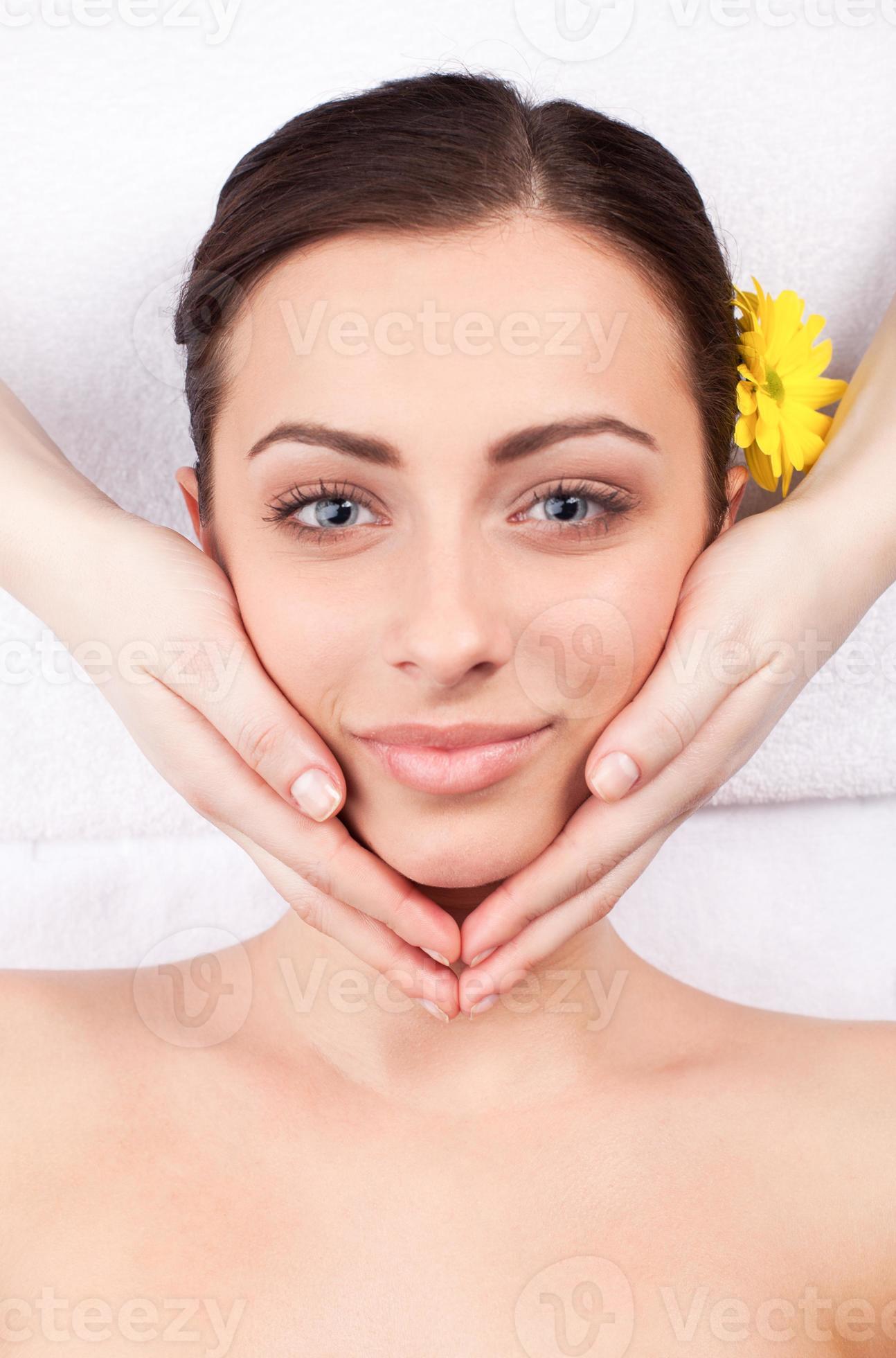 Facial Massage Top View Of Attractive Young Woman Lying Down And Looking At Camera While