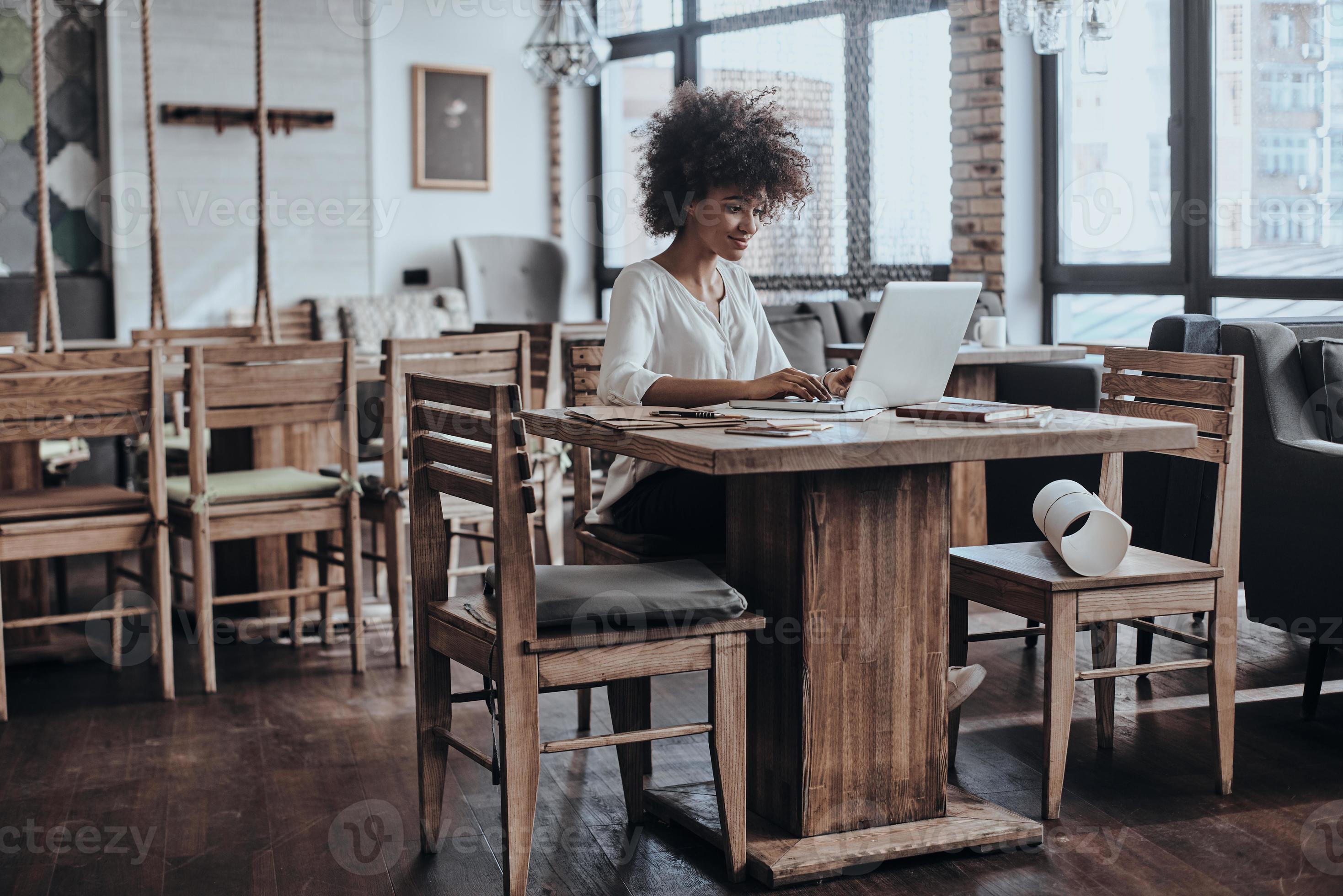 Working on new project. Beautiful young African woman in smart casual ... Working on new project. Beautiful young African woman in smart casual ...