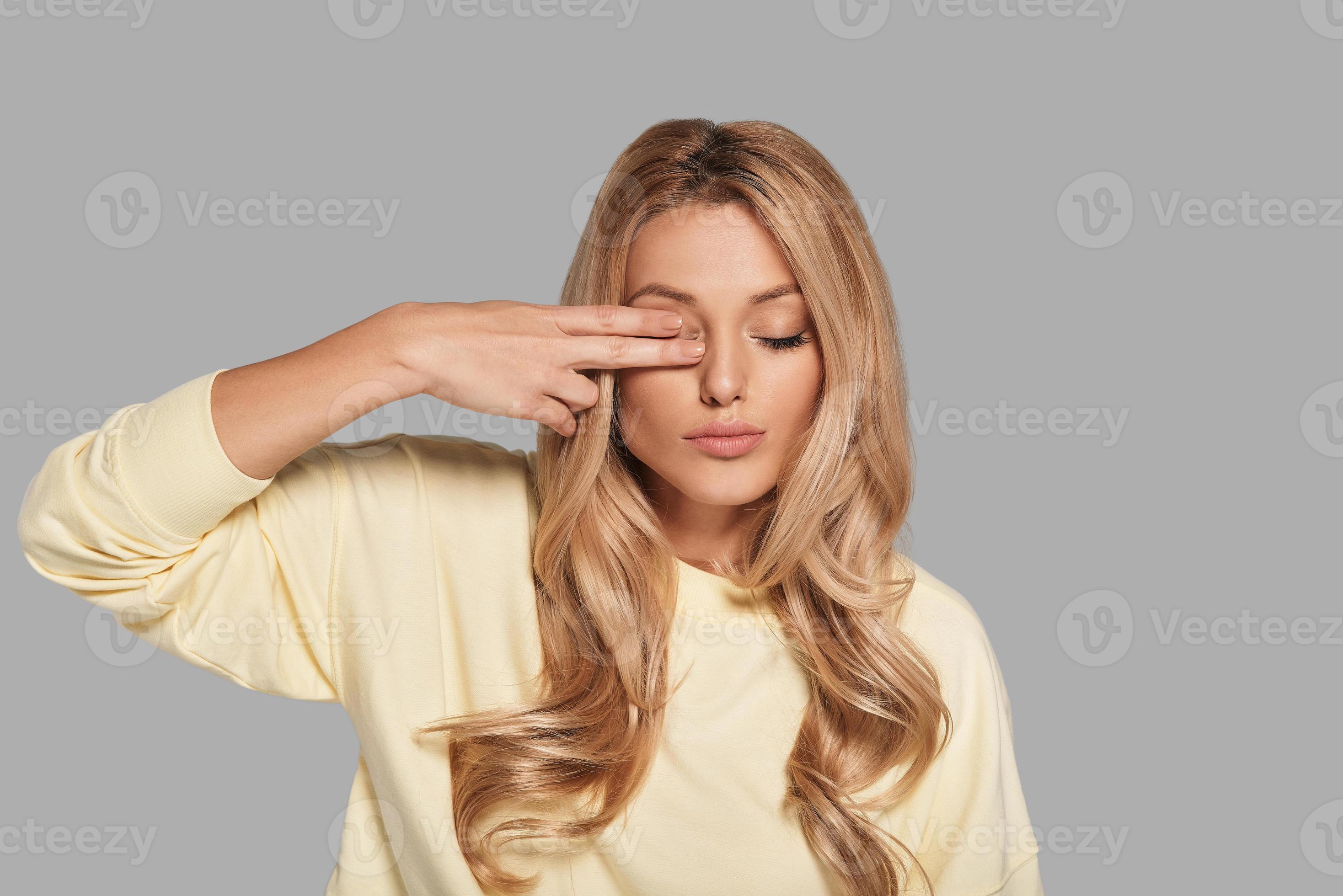 Young And Beautiful Attractive Young Woman Covering Eye With Fingers