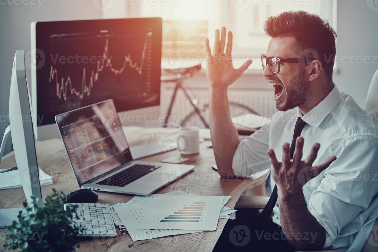 Great Surprised young businessman in formalwear shouting and gesturing ...