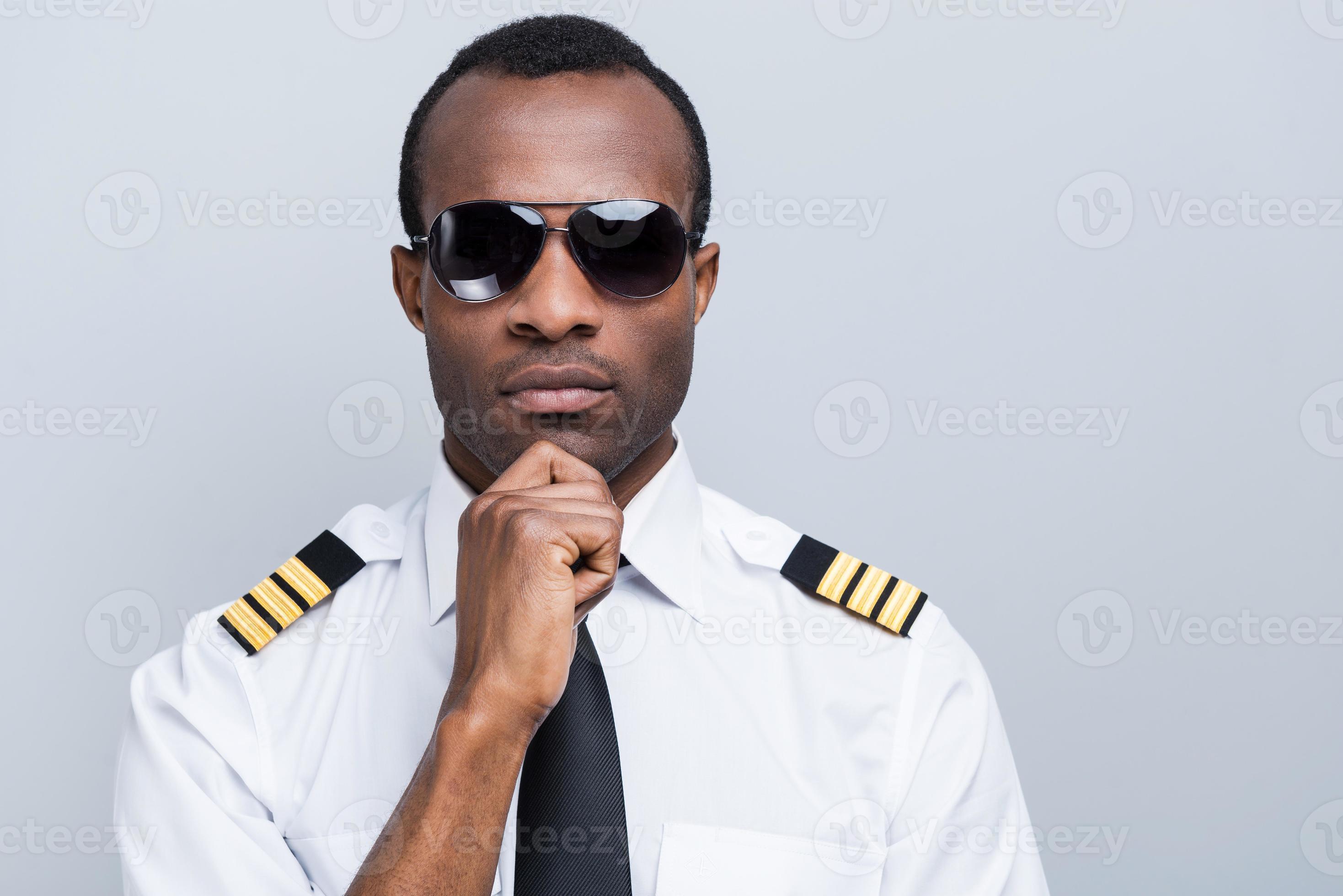 Confident and experienced pilot. Confident African pilot in uniform ... Confident and experienced pilot. Confident African pilot in uniform ...