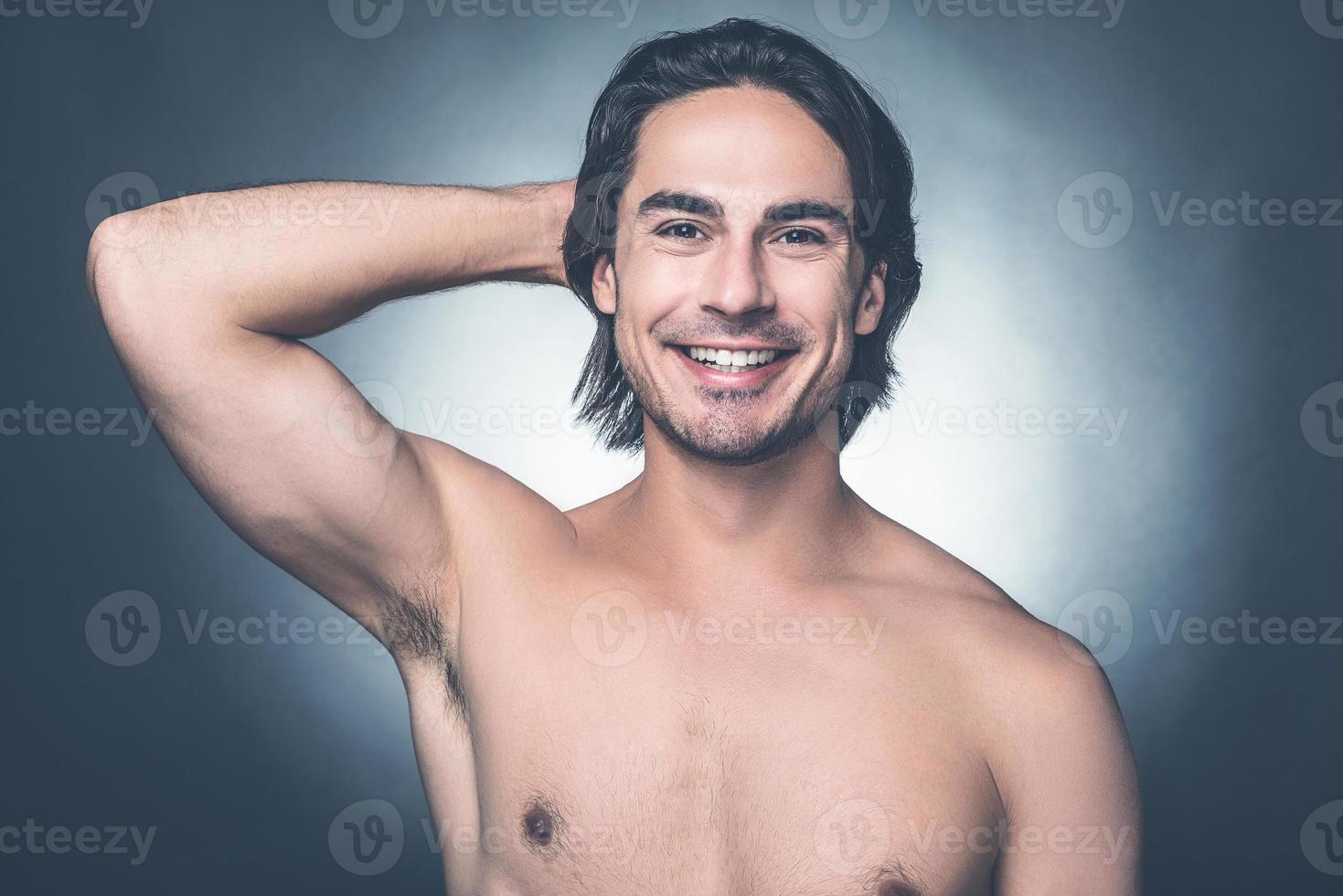 Looking good and feeling great. Portrait of young shirtless man looking ...