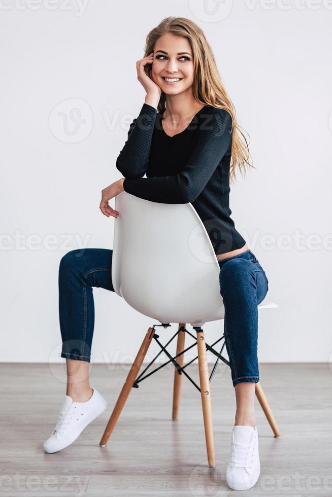 Stunning cutie. Beautiful young woman looking away with smile while ...