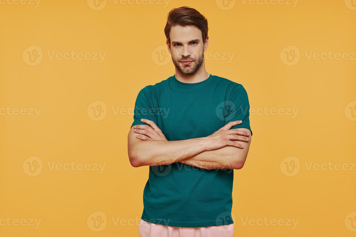 Handsome young man in casual clothing looking at camera while standing ...