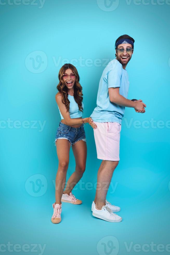 Full Length Of Beautiful Young Couple Having Fun While Standing Against
