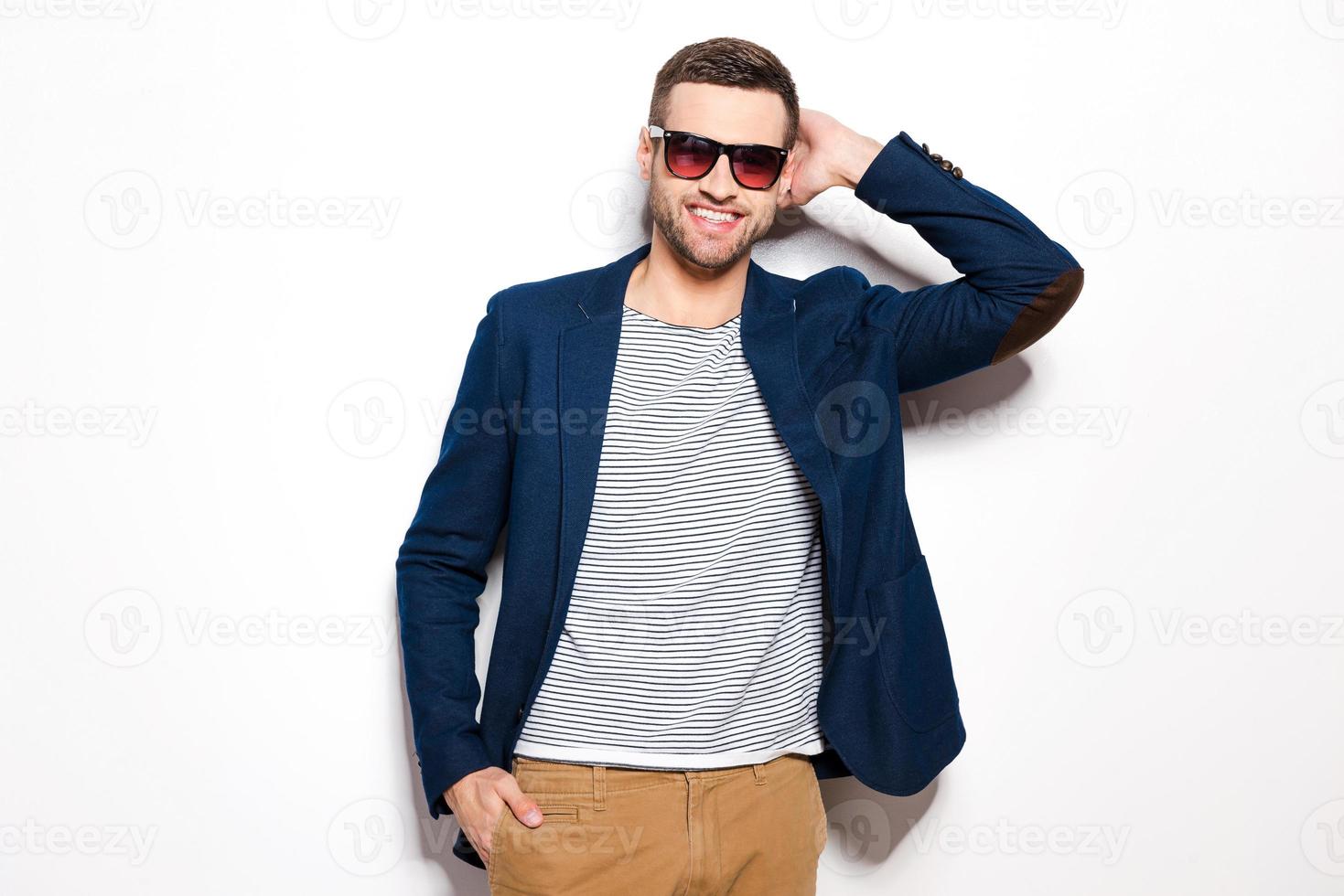 Confident and handsome. Handsome young man in sunglasses holding hand ... Confident and handsome. Handsome young man in sunglasses holding hand ...