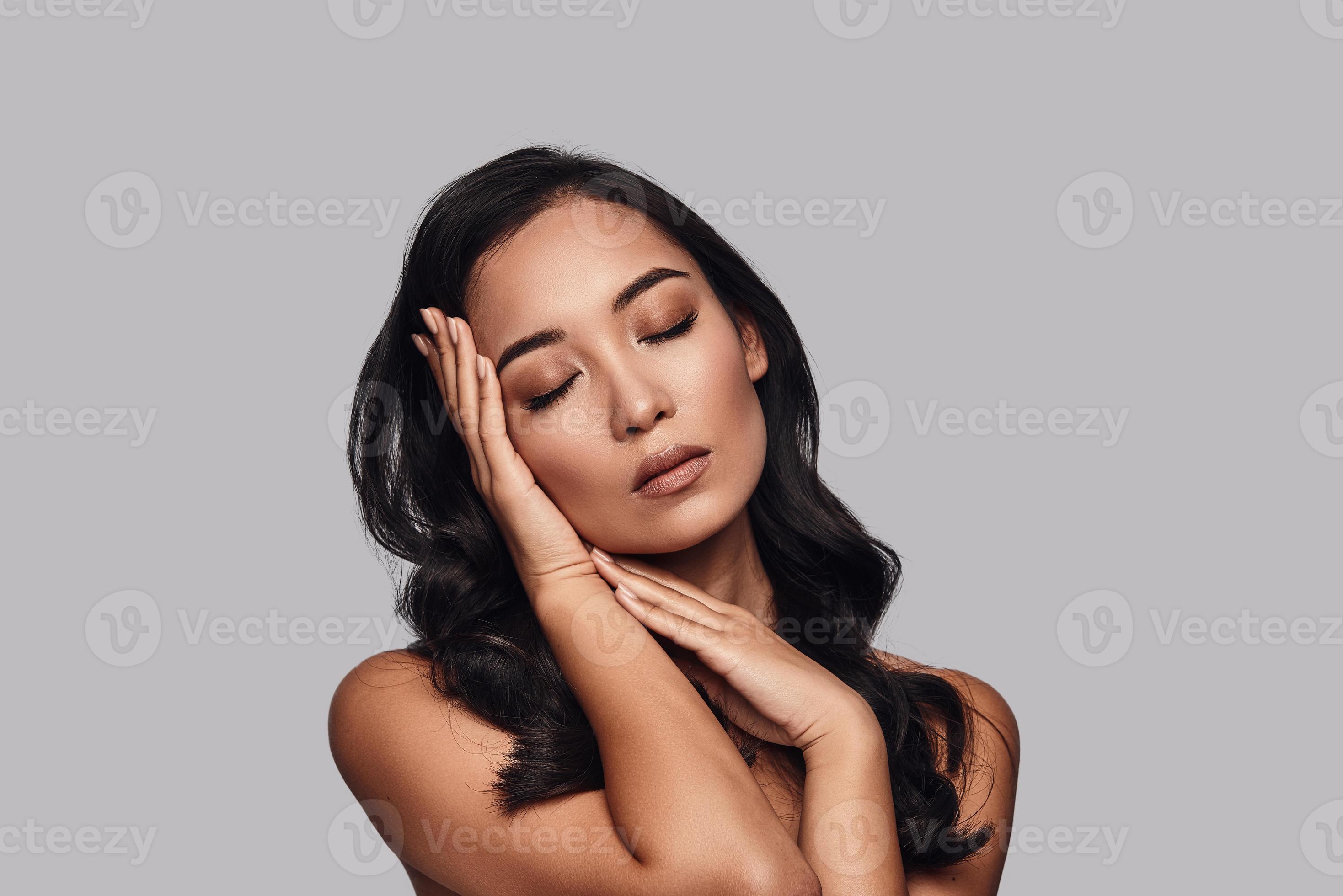 Natural and beautiful. Beautiful young woman keeping eyes closed while ... Natural and beautiful. Beautiful young woman keeping eyes closed while ...