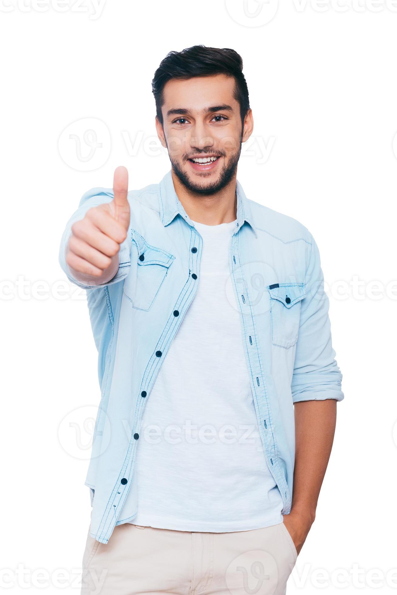 Good job Happy young Indian man showing his thumb up and smiling while ...