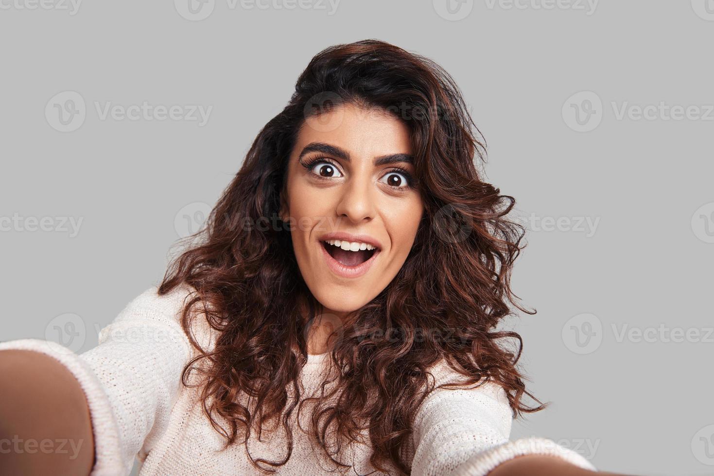 Funny Selfie Self Portrait Of Playful Young Smiling Woman Making A Face And Looking At Camera