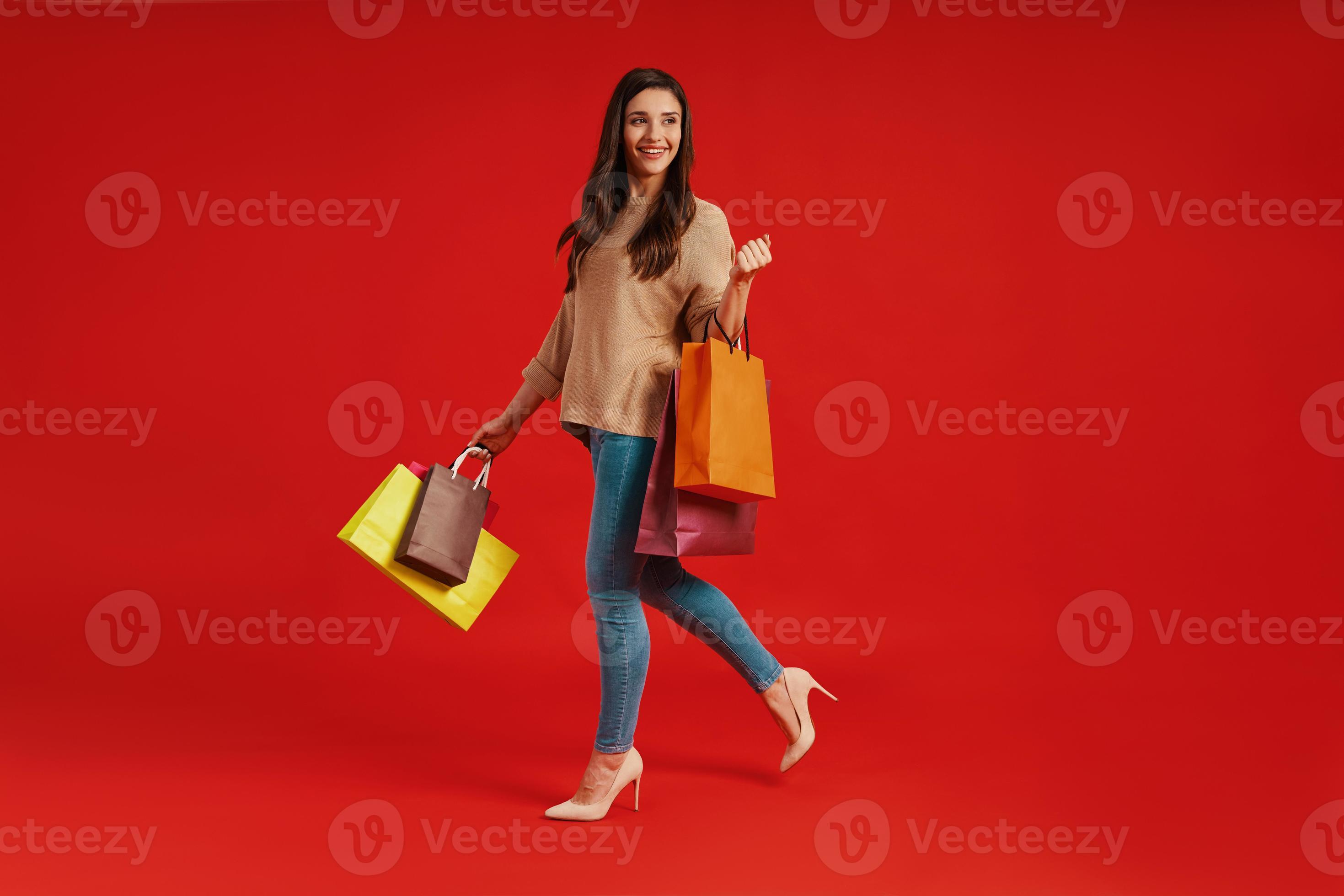 Full length of beautiful young woman in casual clothing carrying ... Full length of beautiful young woman in casual clothing carrying ...