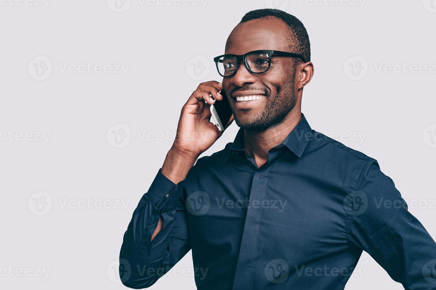 Good talk. Handsome young African man talking on smart phone and ...