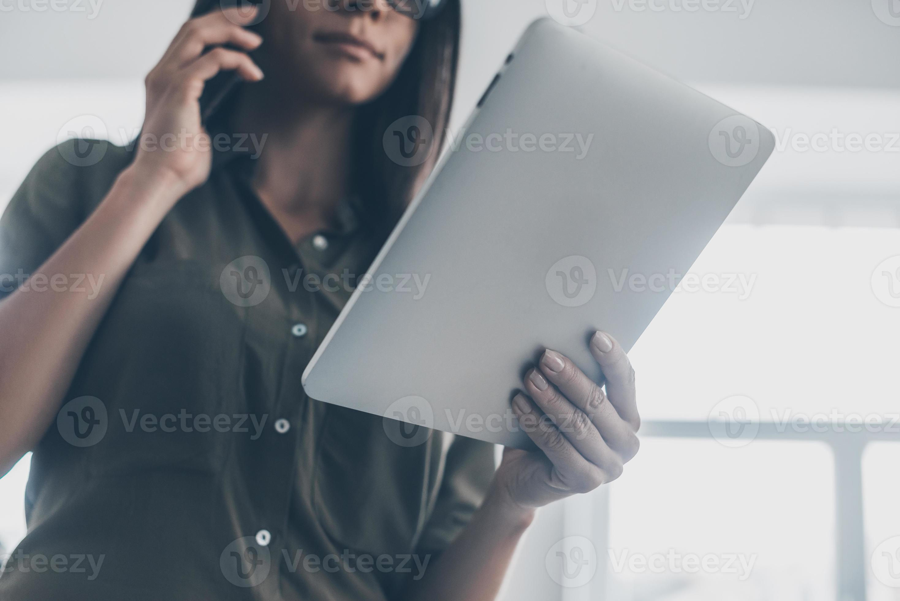 Modern businesswoman. Low angle view of confident young woman in smart ...