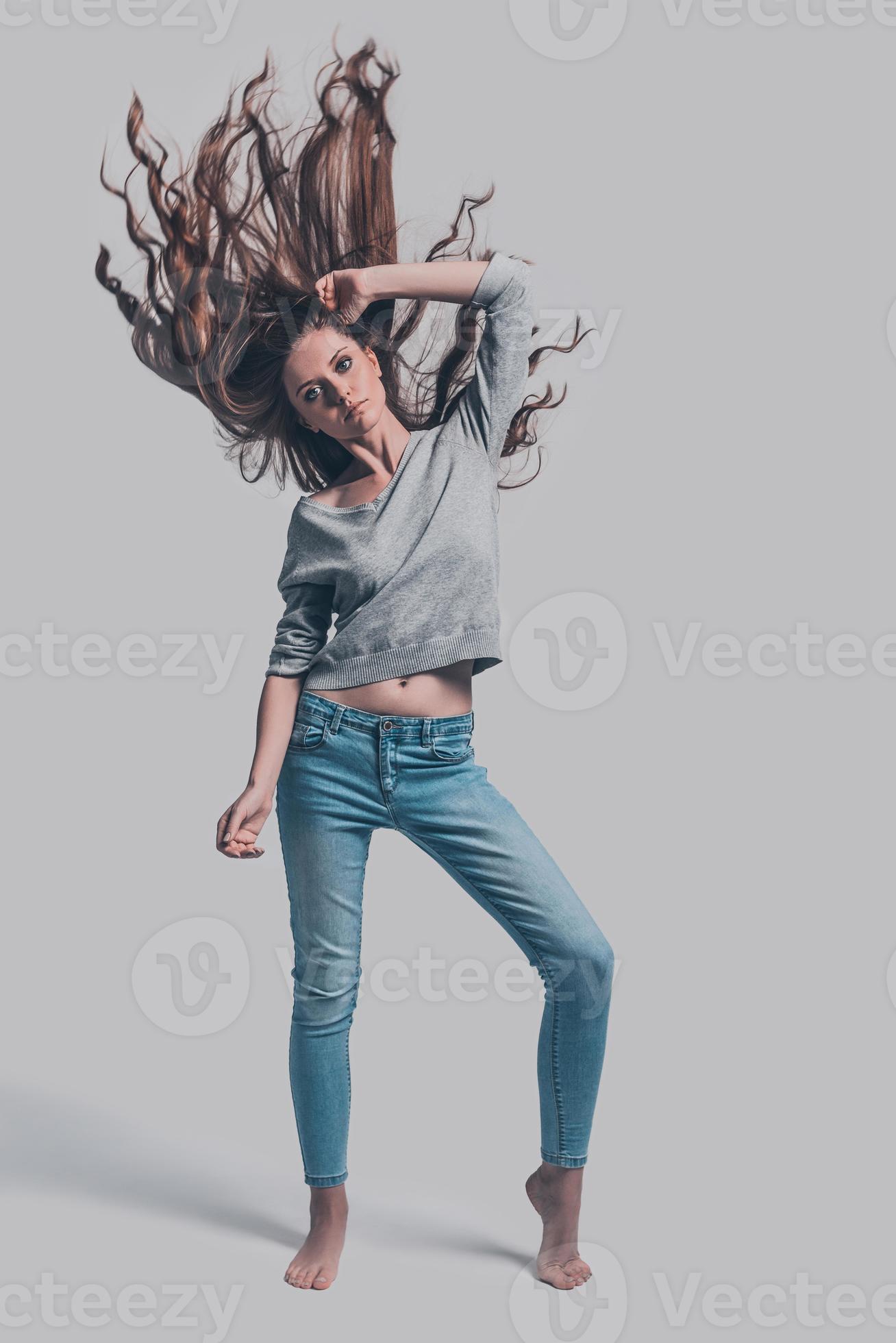 In motion. Full length studio shot of attractive young woman with ...