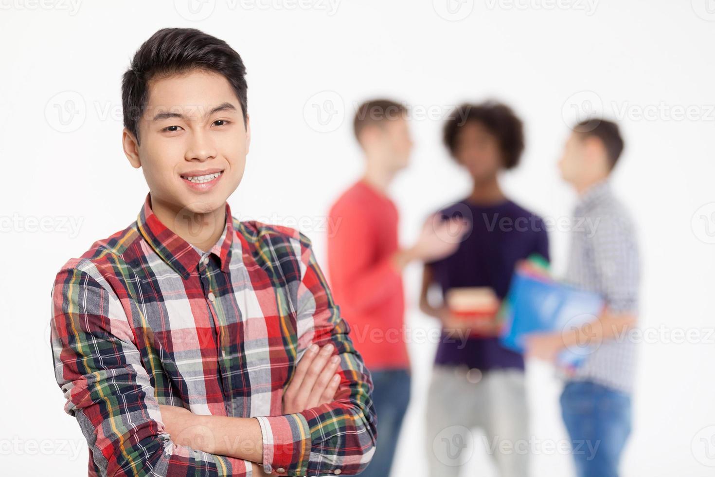 Confident in his friends. Cheerful Chinese teenage boy keeping arms ... Confident in his friends. Cheerful Chinese teenage boy keeping arms ...