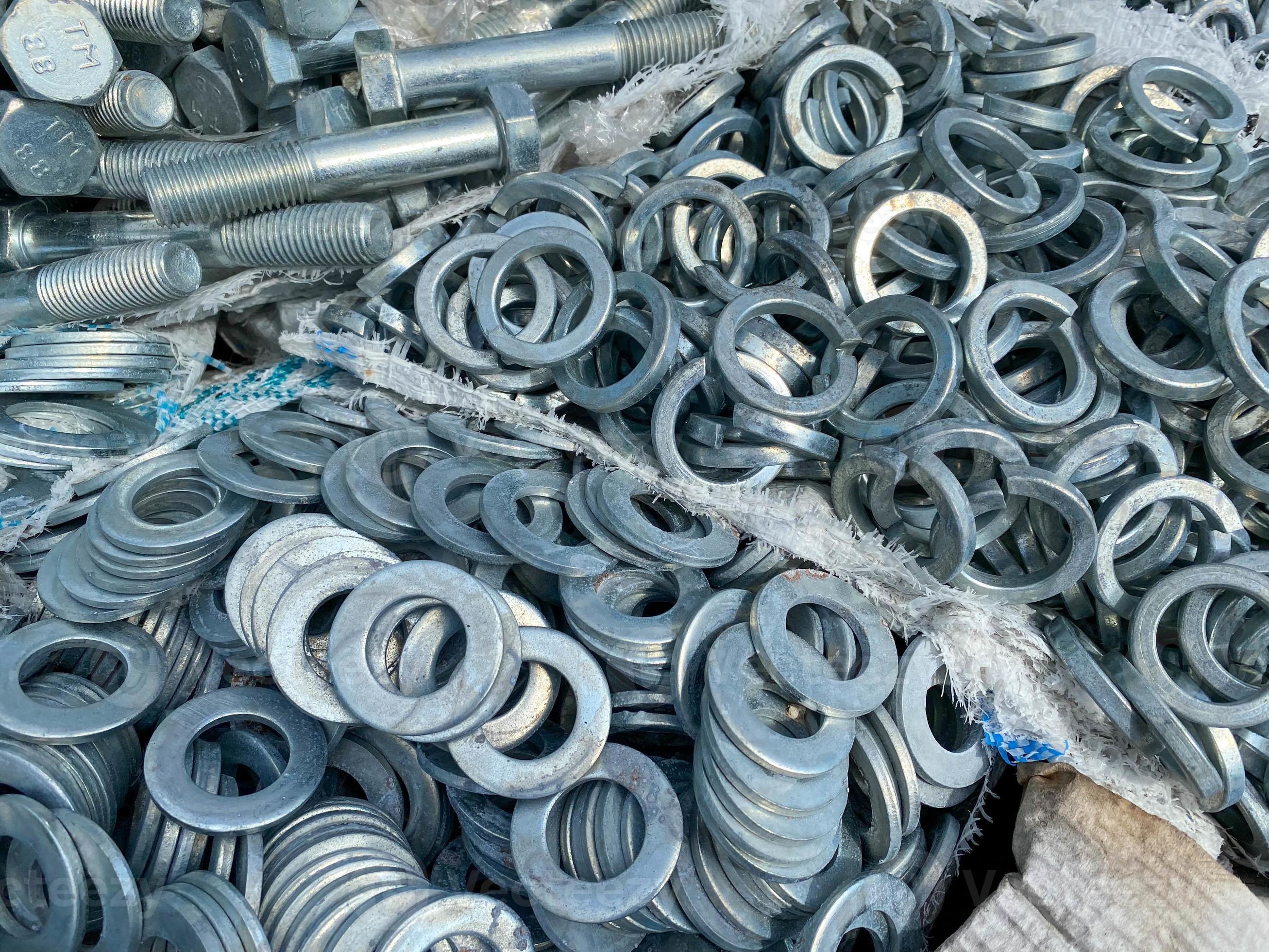 Background, texture of many metal small iron round washers for bolts and stainless steel ...