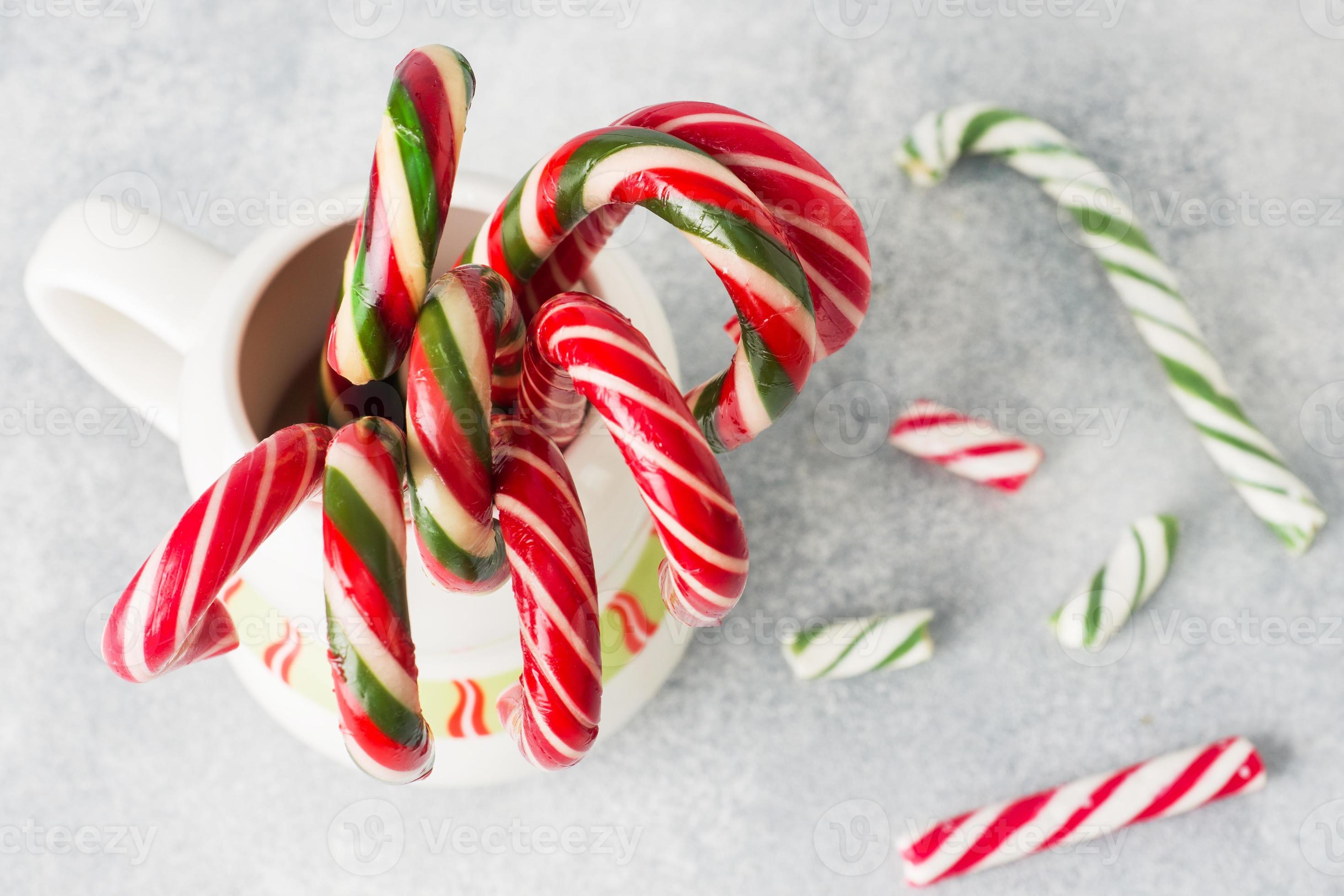 Lots of Christmas candy canes in a mug on a grey background with copy ...