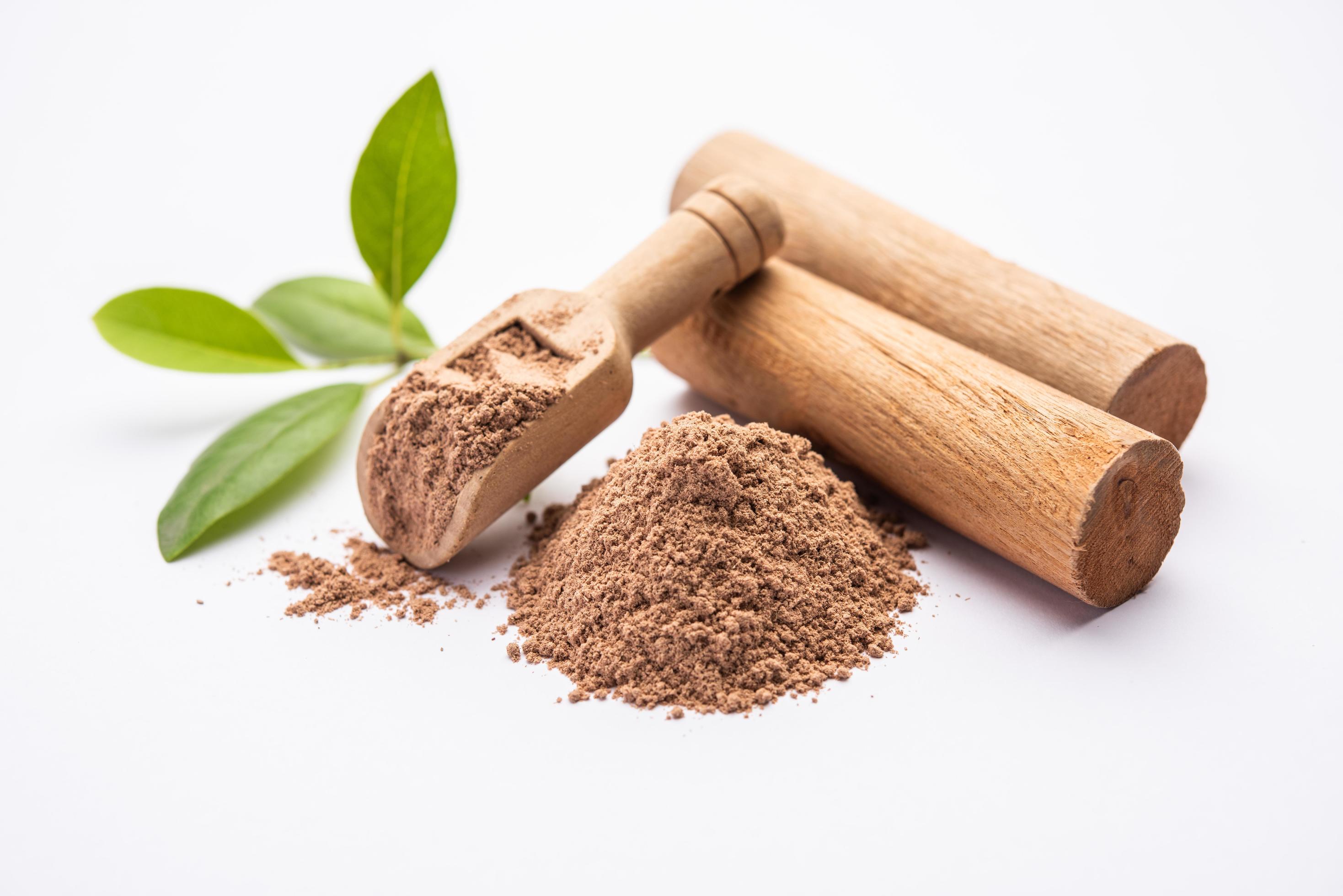 Chandan or sandalwood powder with sticks, perfume or oil which retain their fragrance for ...