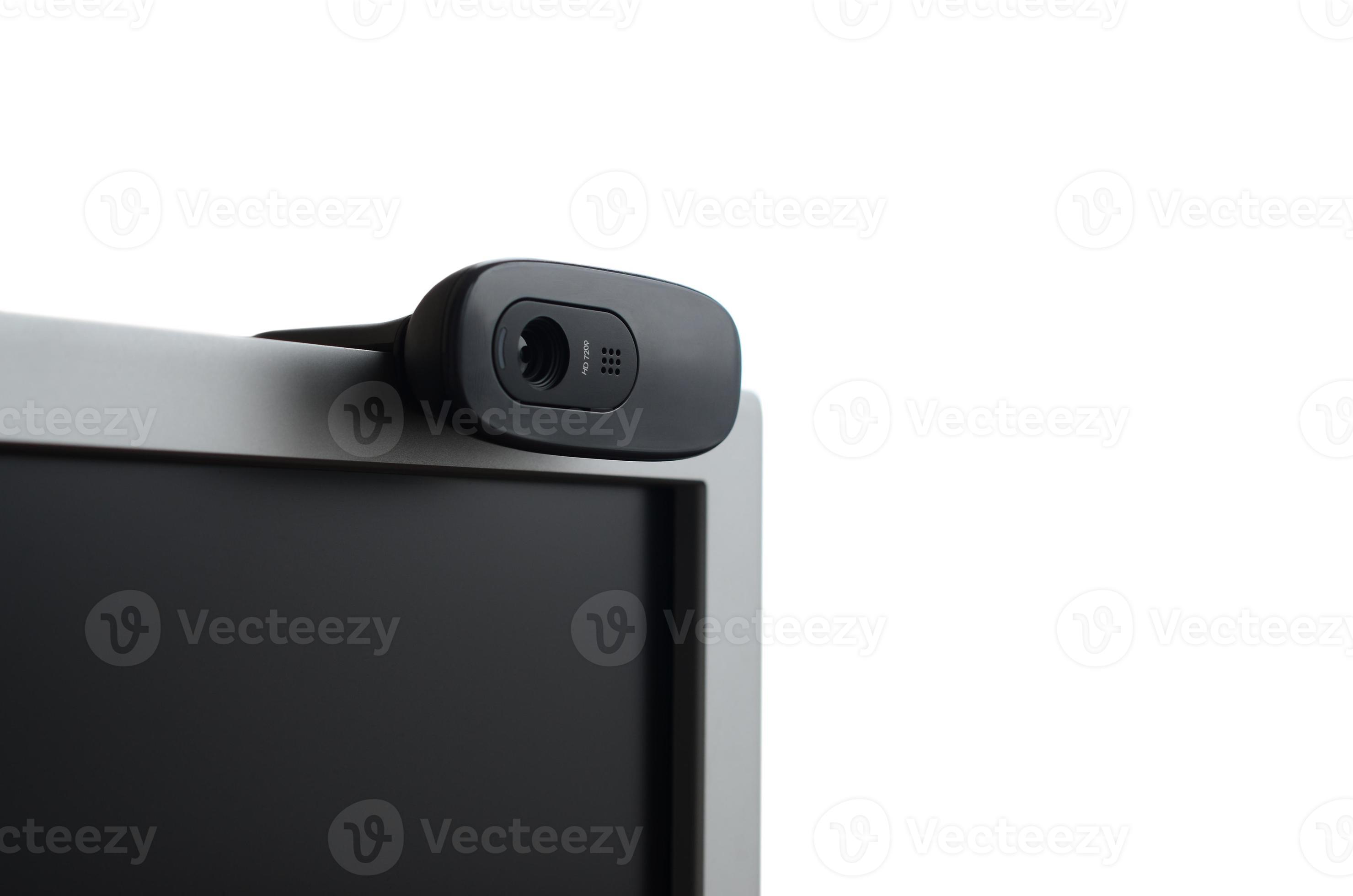 A modern web camera is installed on the body of a flat screen monitor. Device for video ...