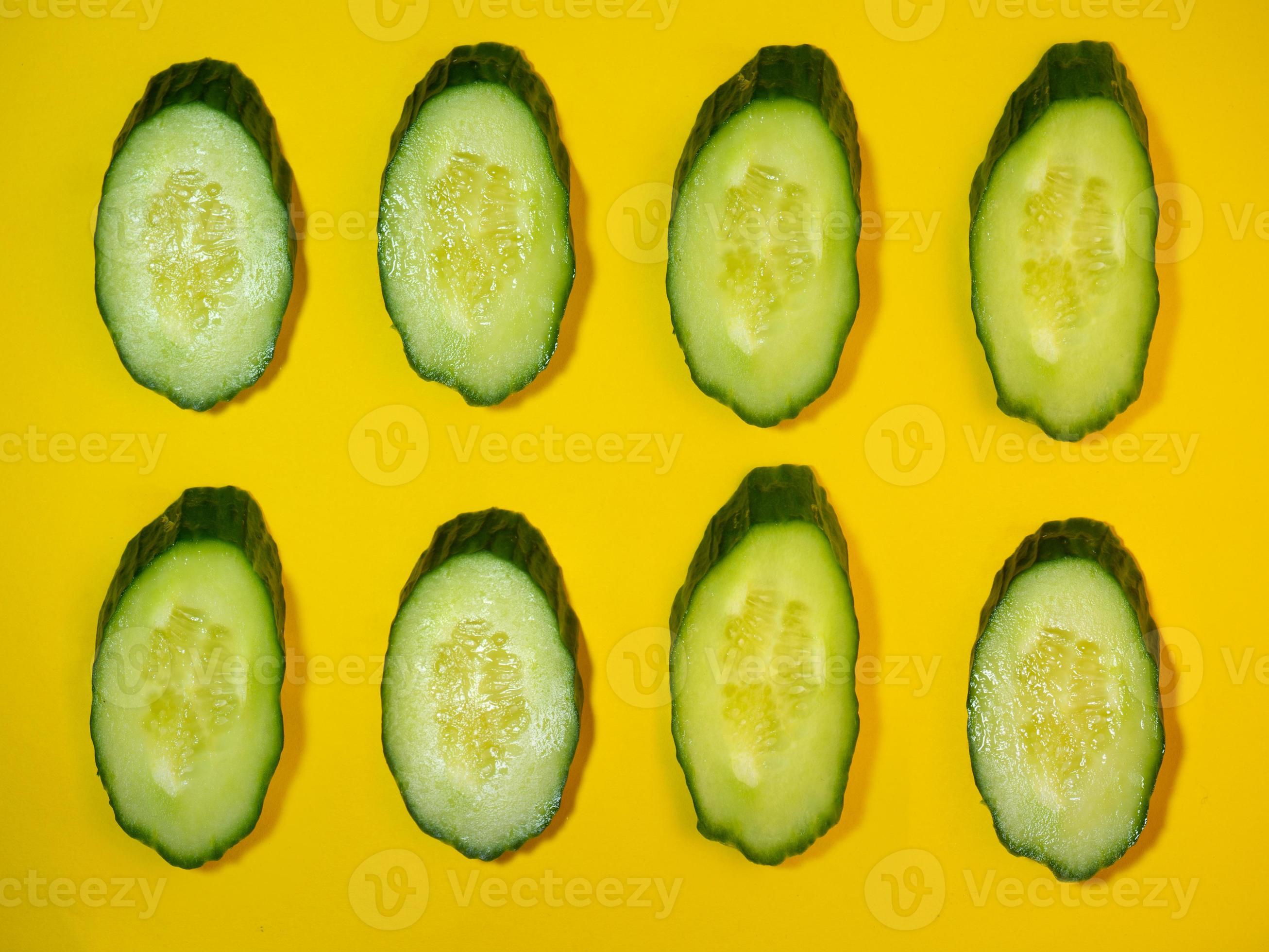A smooth, medium-sized cucumber cut into slices. Vegetable isolate. Background of slices ...