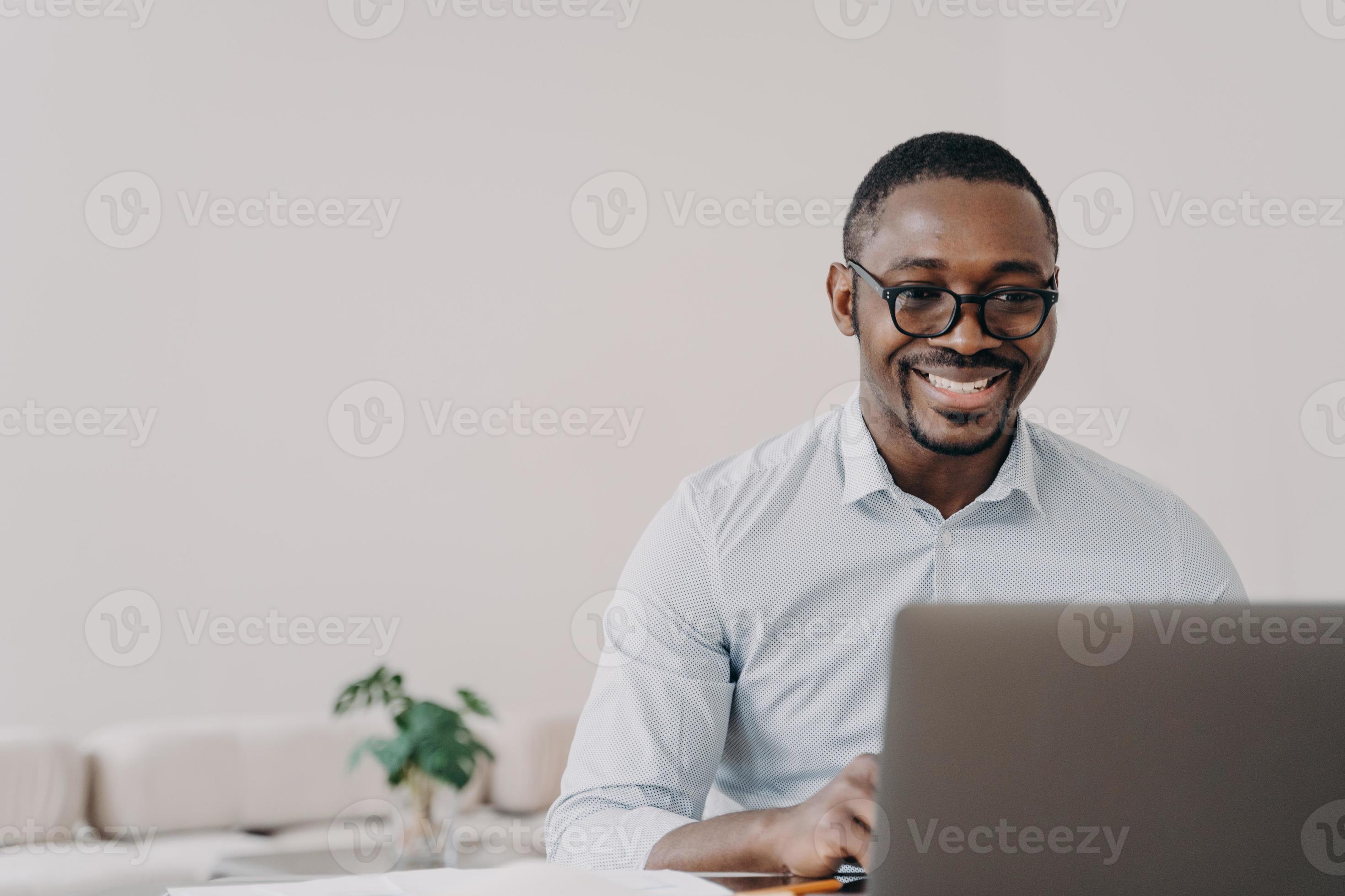 Smiling african american man software developer working online at ...