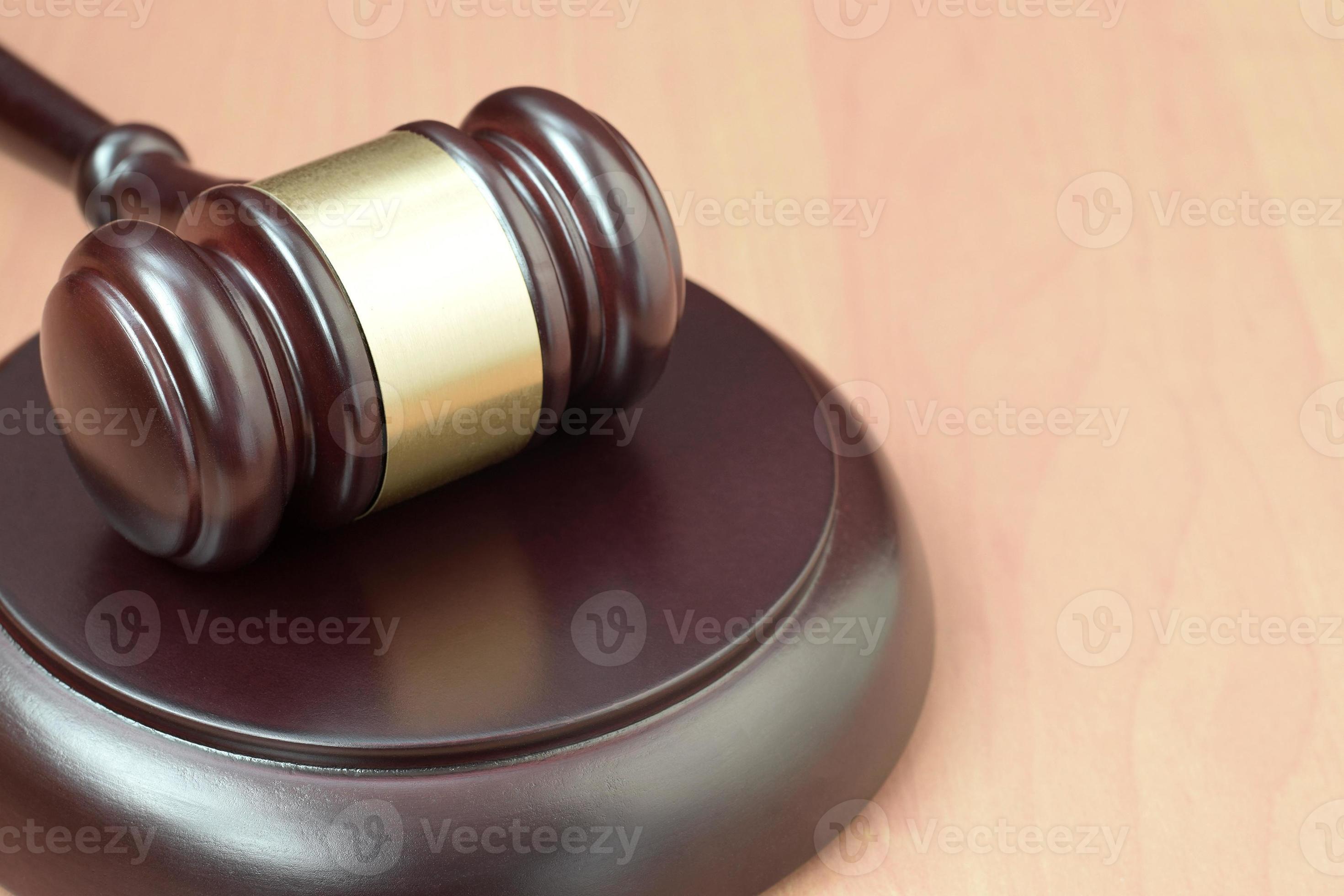Justice mallet on wooden desk in a courtroom during a judicial trial. Law concept and empty ...