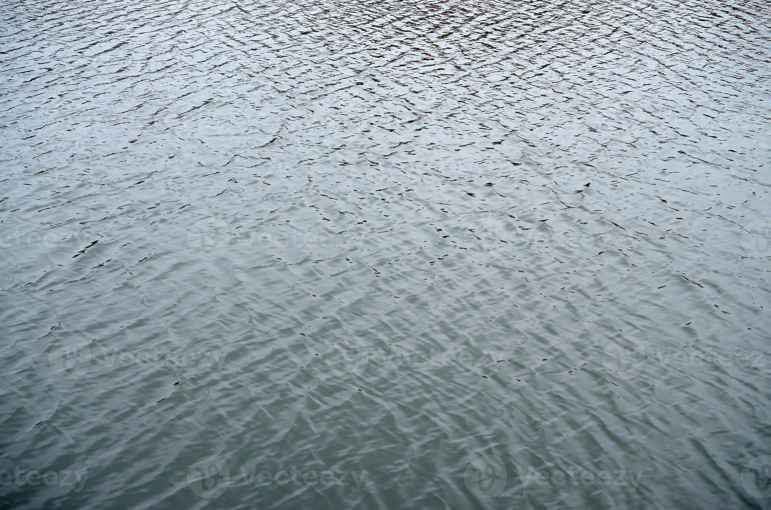 The texture of the water in the river under the influence of wind. A ...