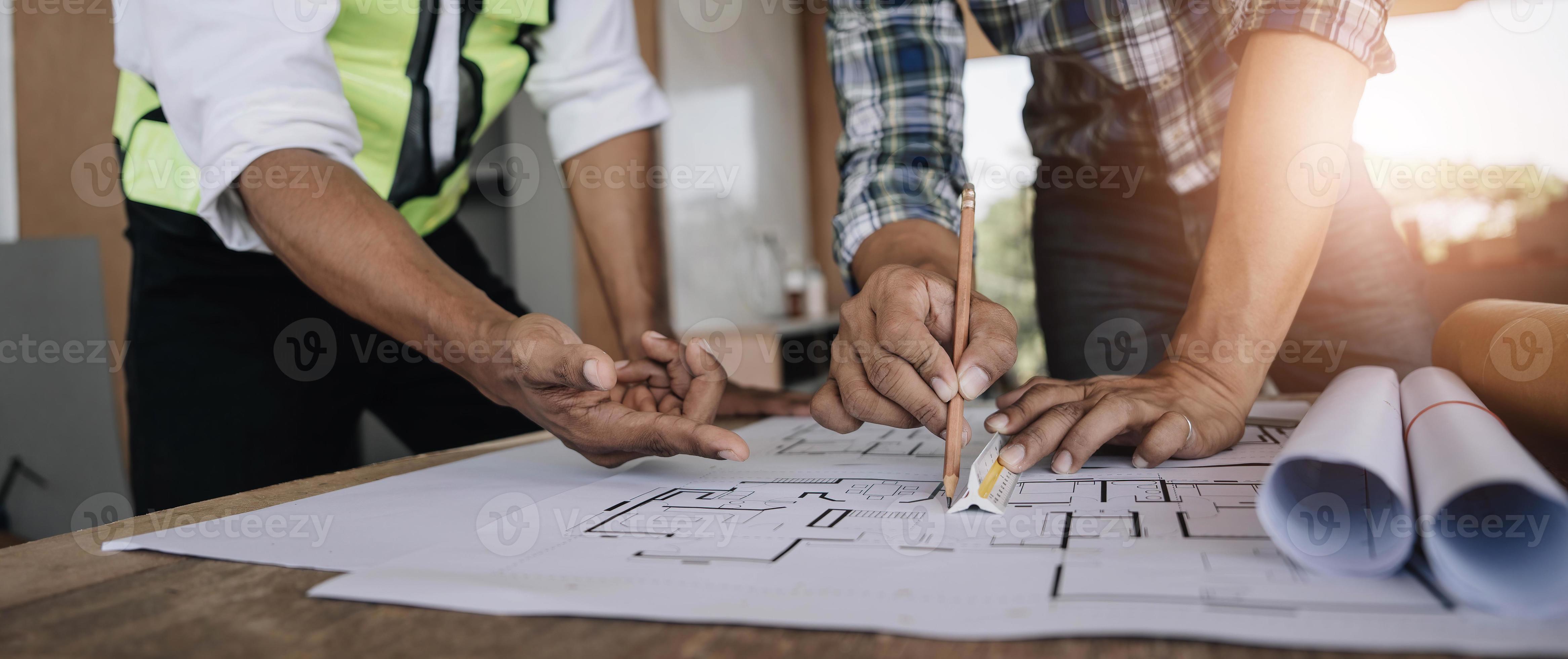 Civil engineer teams meeting working together wear worker helmets hardhat on construction site ...