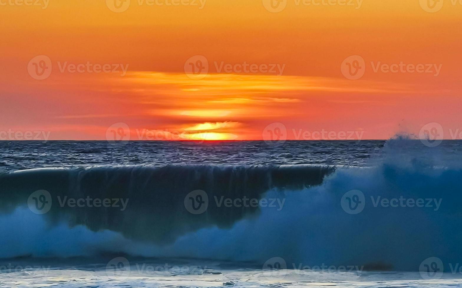 Colorful golden sunset big wave and beach Puerto Escondido Mexico ...