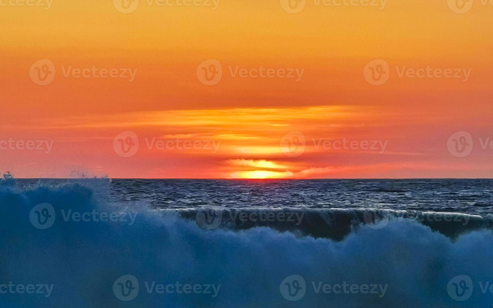 Colorful golden sunset big wave and beach Puerto Escondido Mexico ...