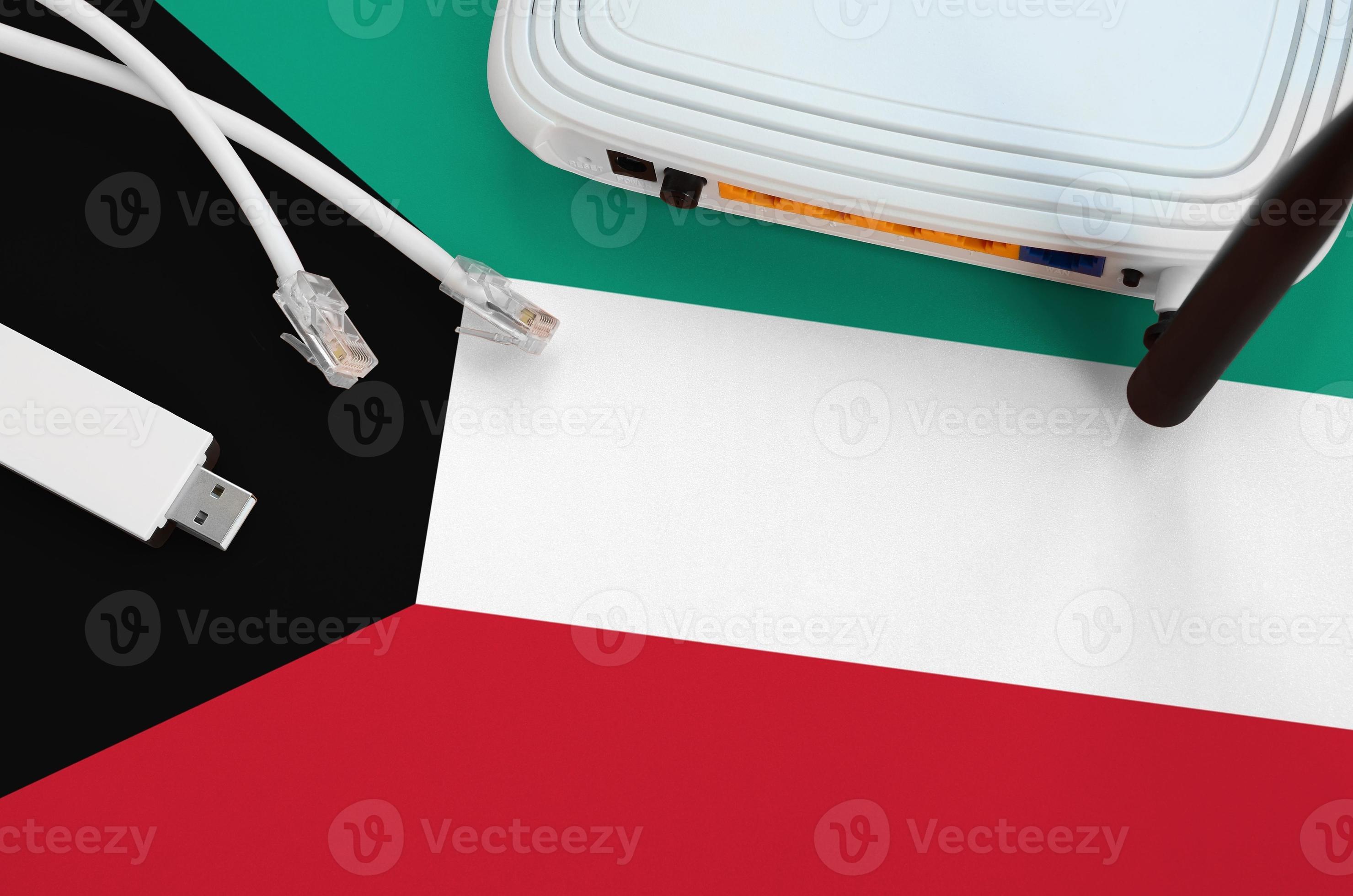 Kuwait flag depicted on table with internet rj45 cable, wireless usb wifi adapter and router ...