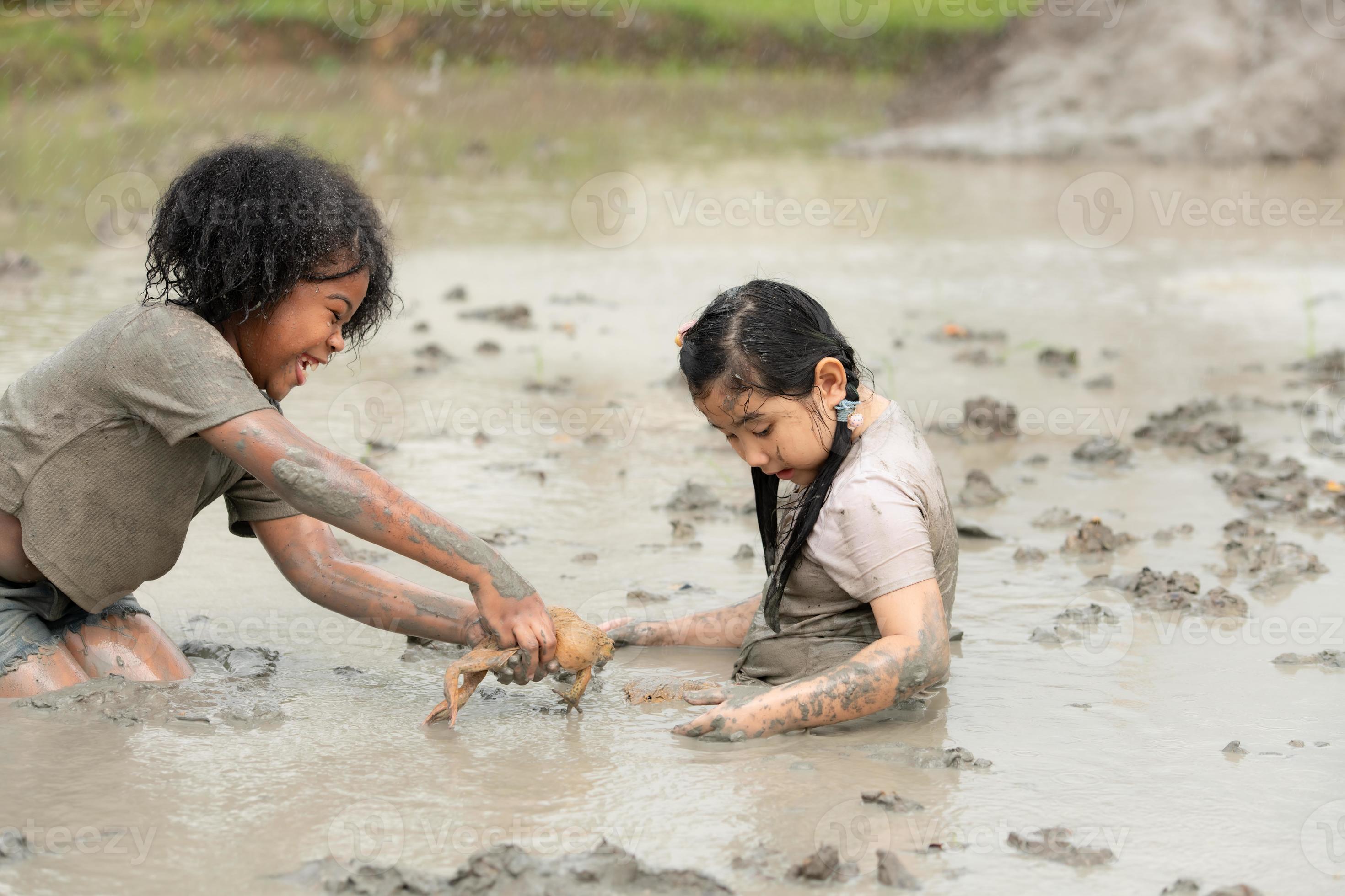 Children have fun playing in the mud in the community fields and ... Children have fun playing in the mud in the community fields and ...