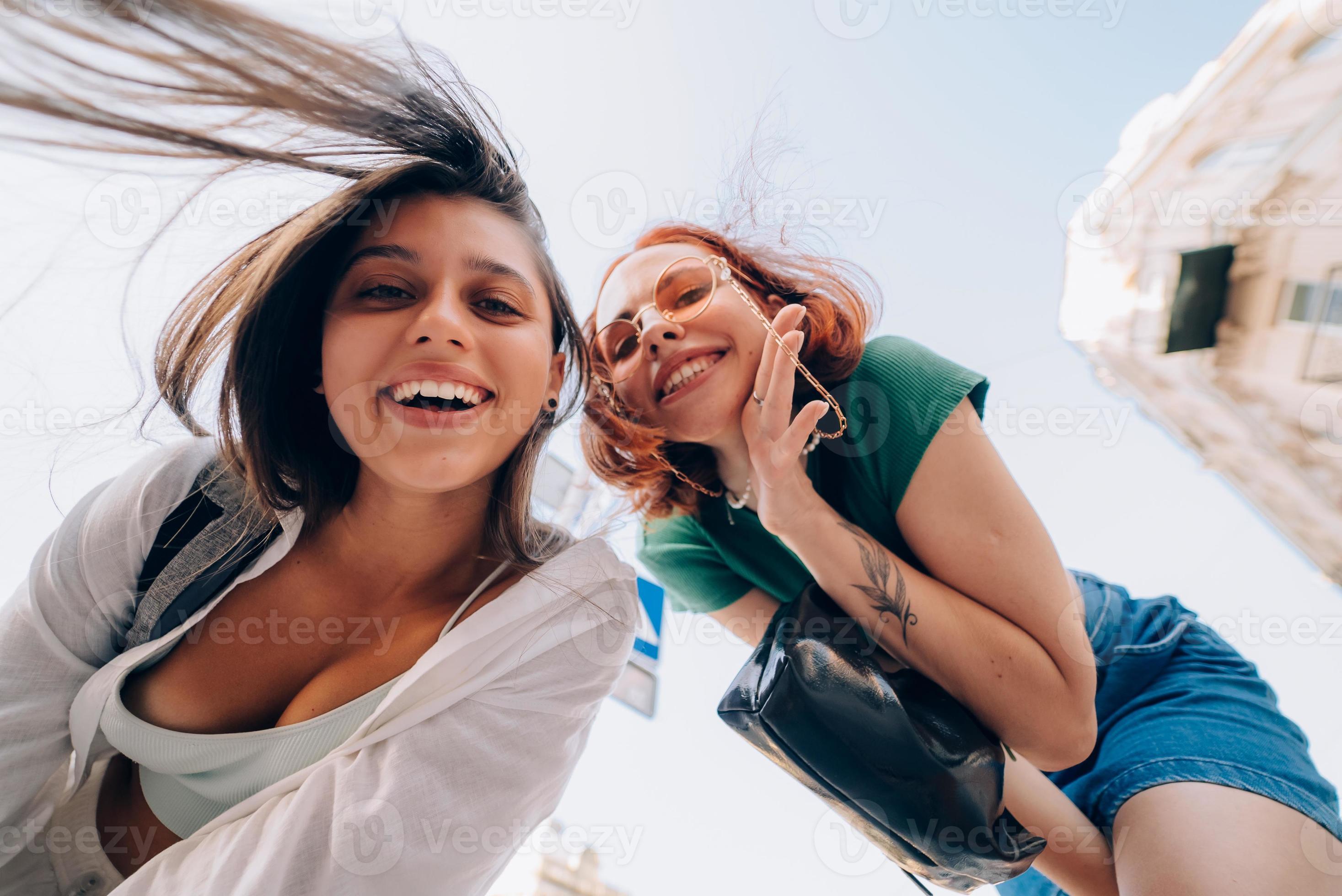 Two friends looks down outdoors in the street at camera 14201949 Stock Photo at Vecteezy