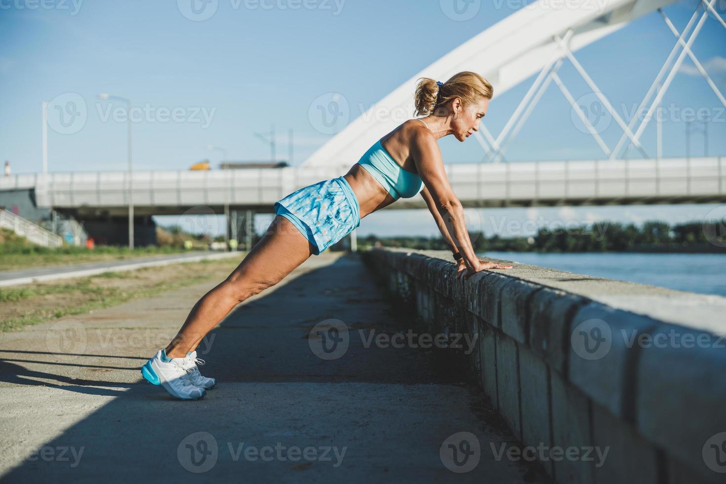 Fit Woman Practicing Push-ups During Outdoors Workout 14234163 Stock Photo at Vecteezy