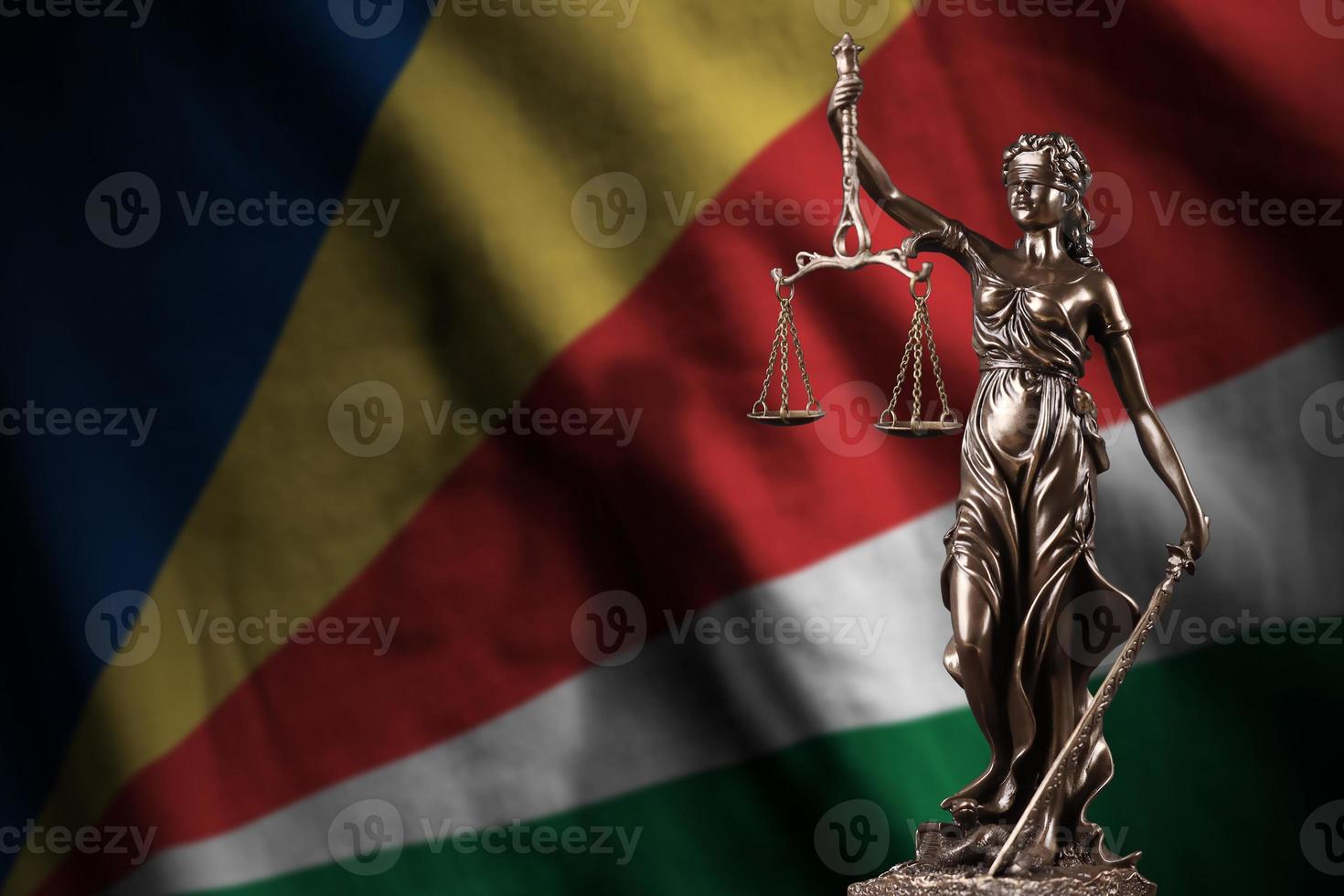 Seychelles Flag With Statue Of Lady Justice And Judicial Scales In Dark