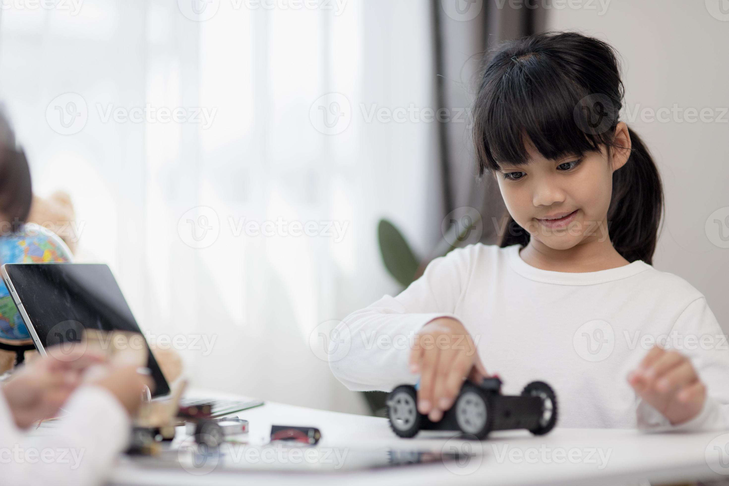 Two Asian students learn coding robot cars and electronic board cables in STEM, STEAM ...