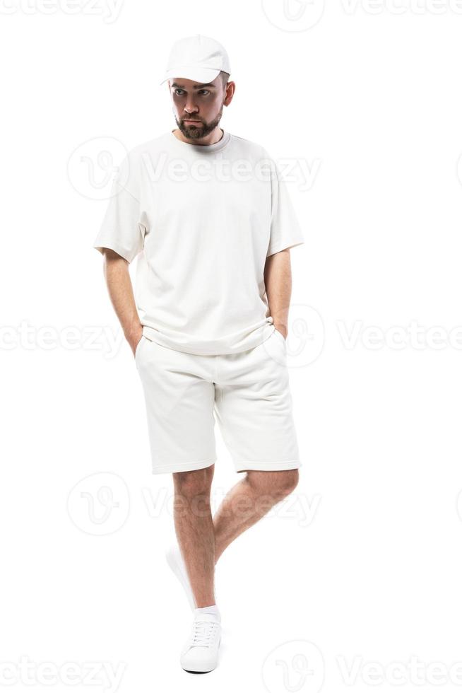 Man wearing blank white cap, t-shirt and shorts on white background ...
