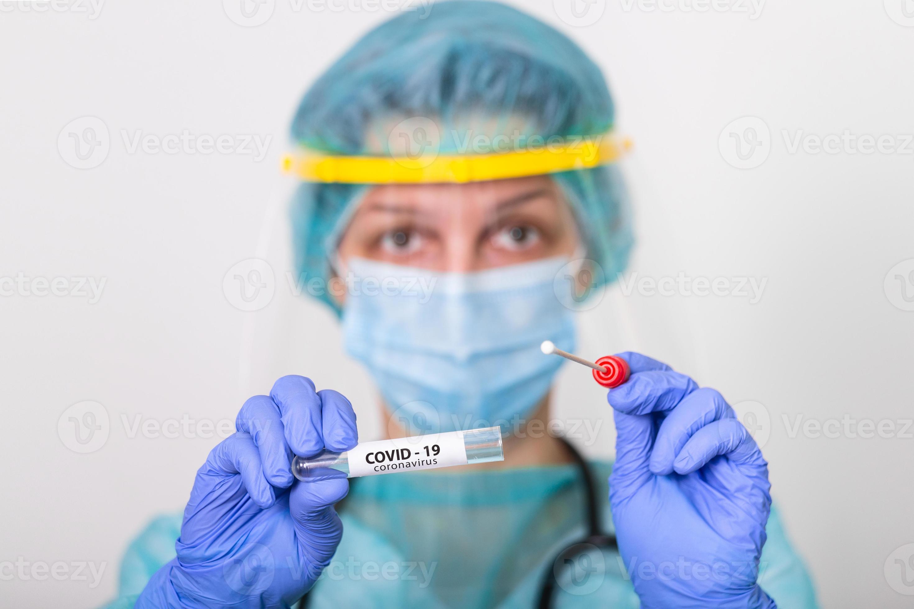 Medical healthcare holding COVID-19 , Coronavirus swab collection kit, wearing PPE protective ...