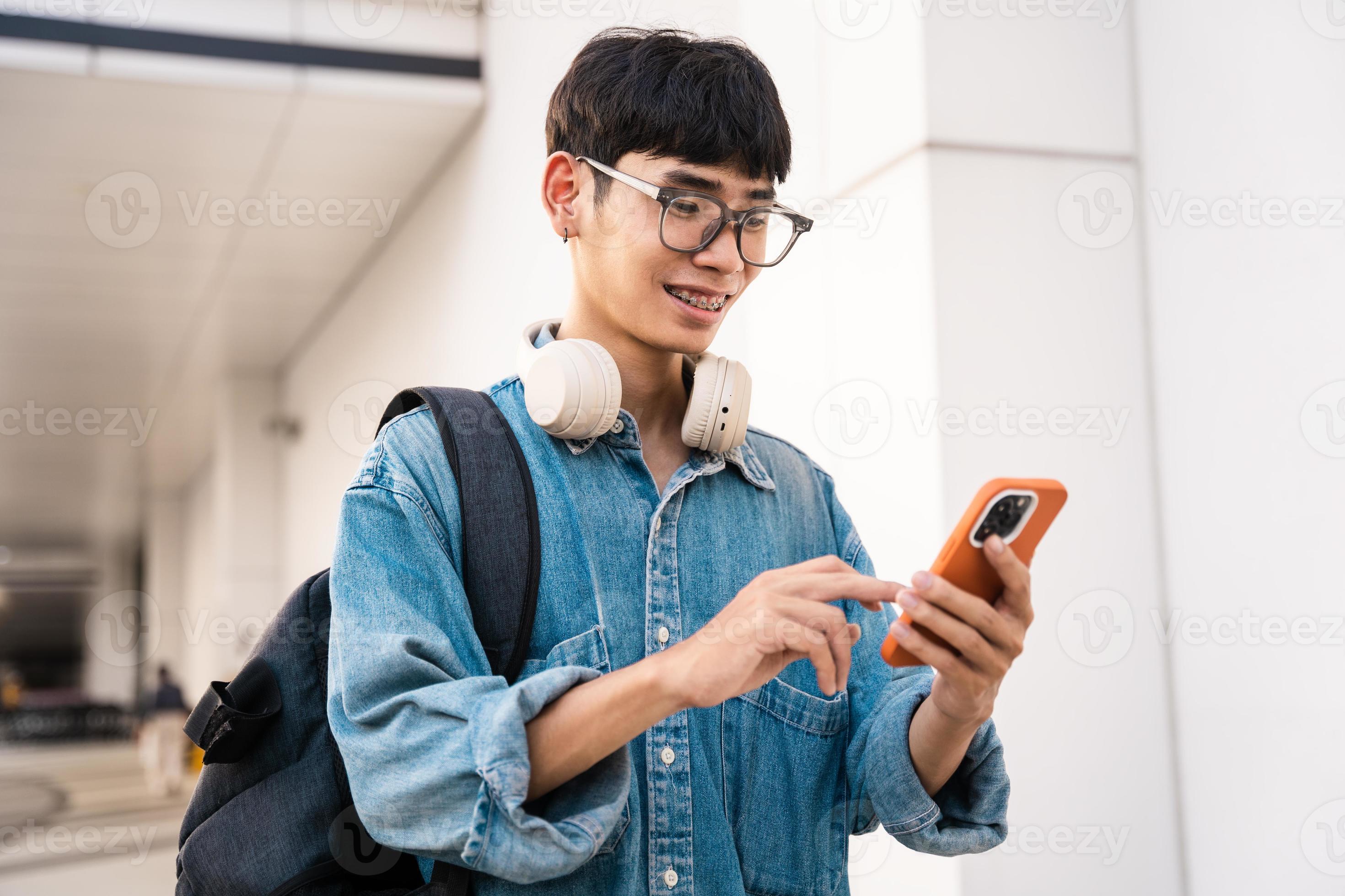 A picture of an Asian male student using a mobile phone 14629144 Stock ...