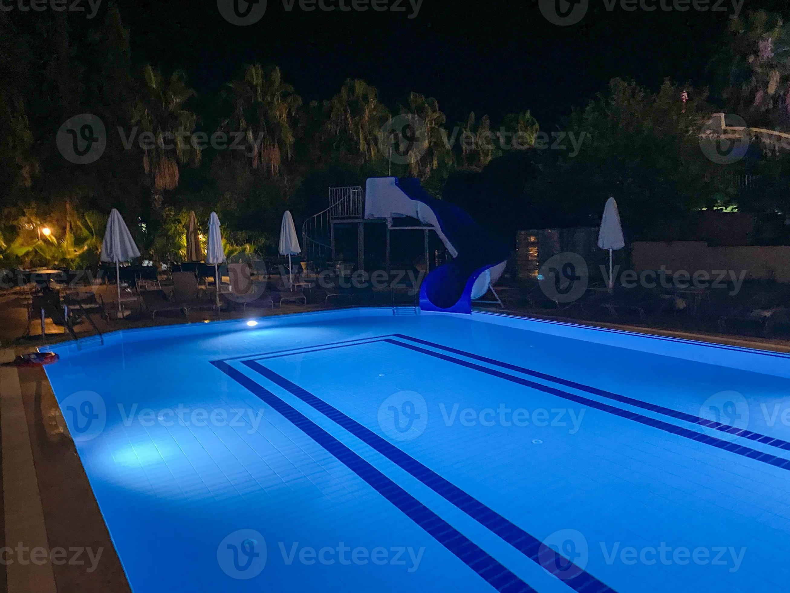 A resort swimming pool at twilight 14710636 Stock Photo at Vecteezy
