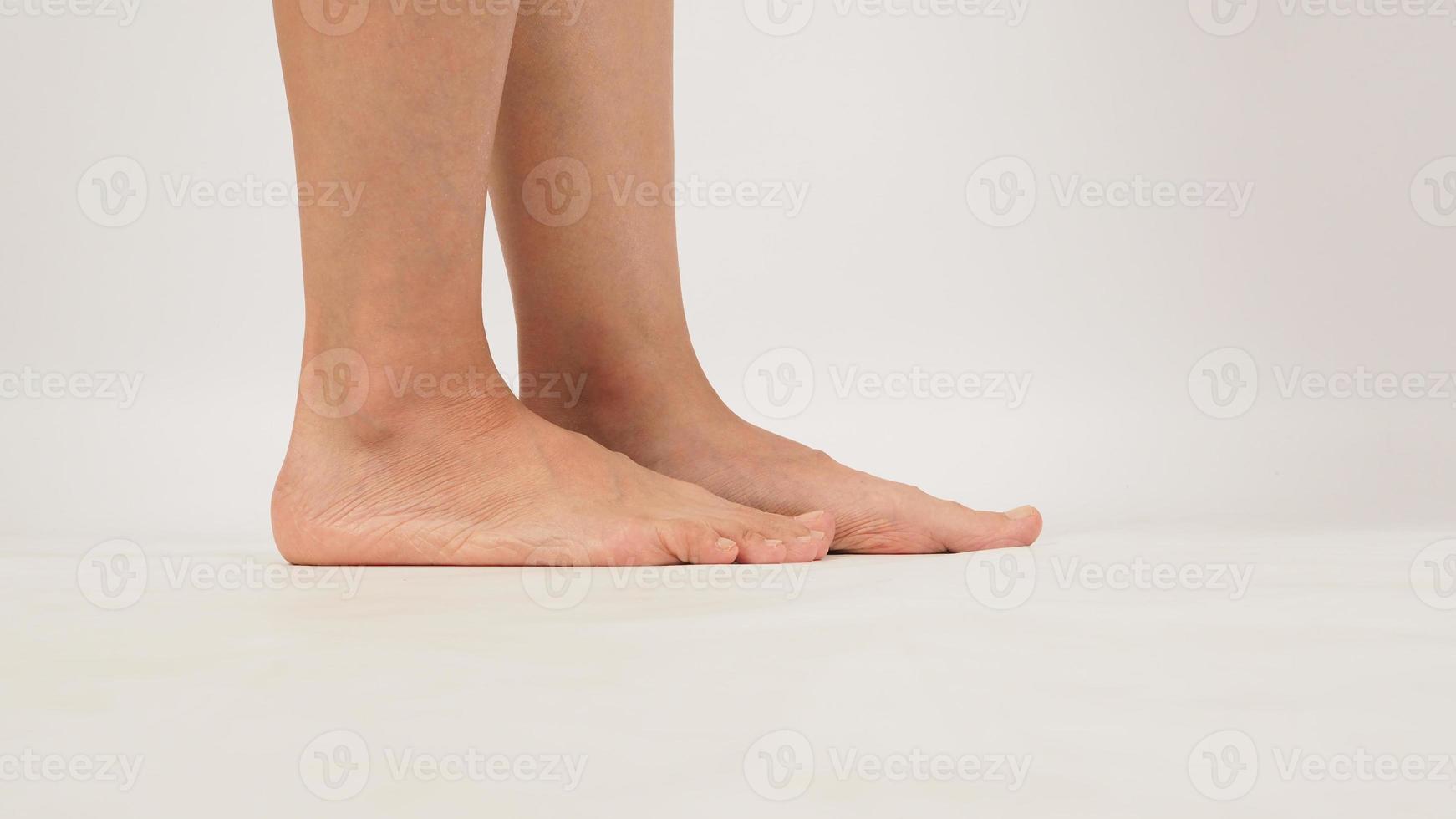 Asian woman is standing with legs and barefoot on white background. Side view 14887026 Stock ...