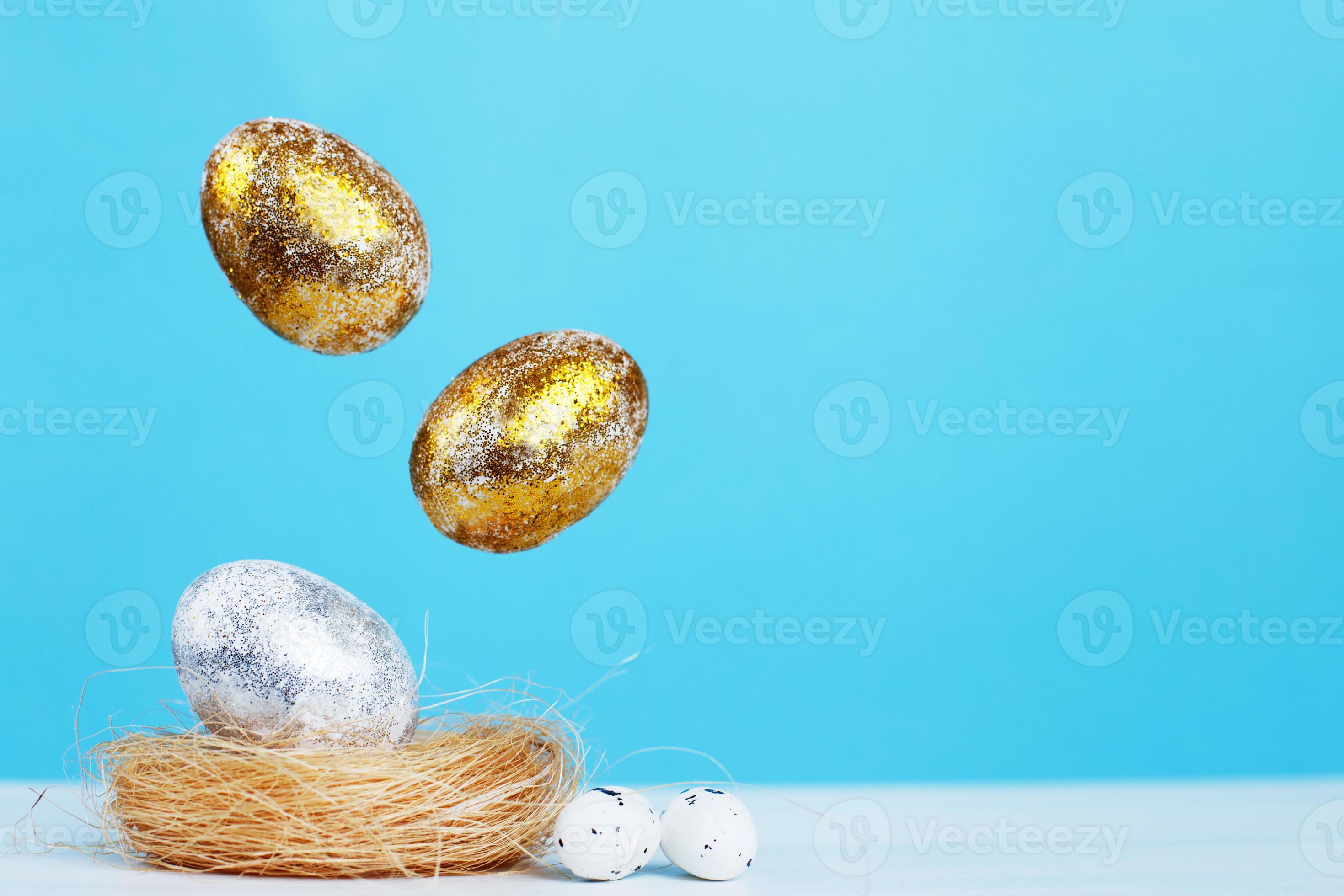 Gold And Silver Easter Eggs Levitation To The Nest On A Blue Background