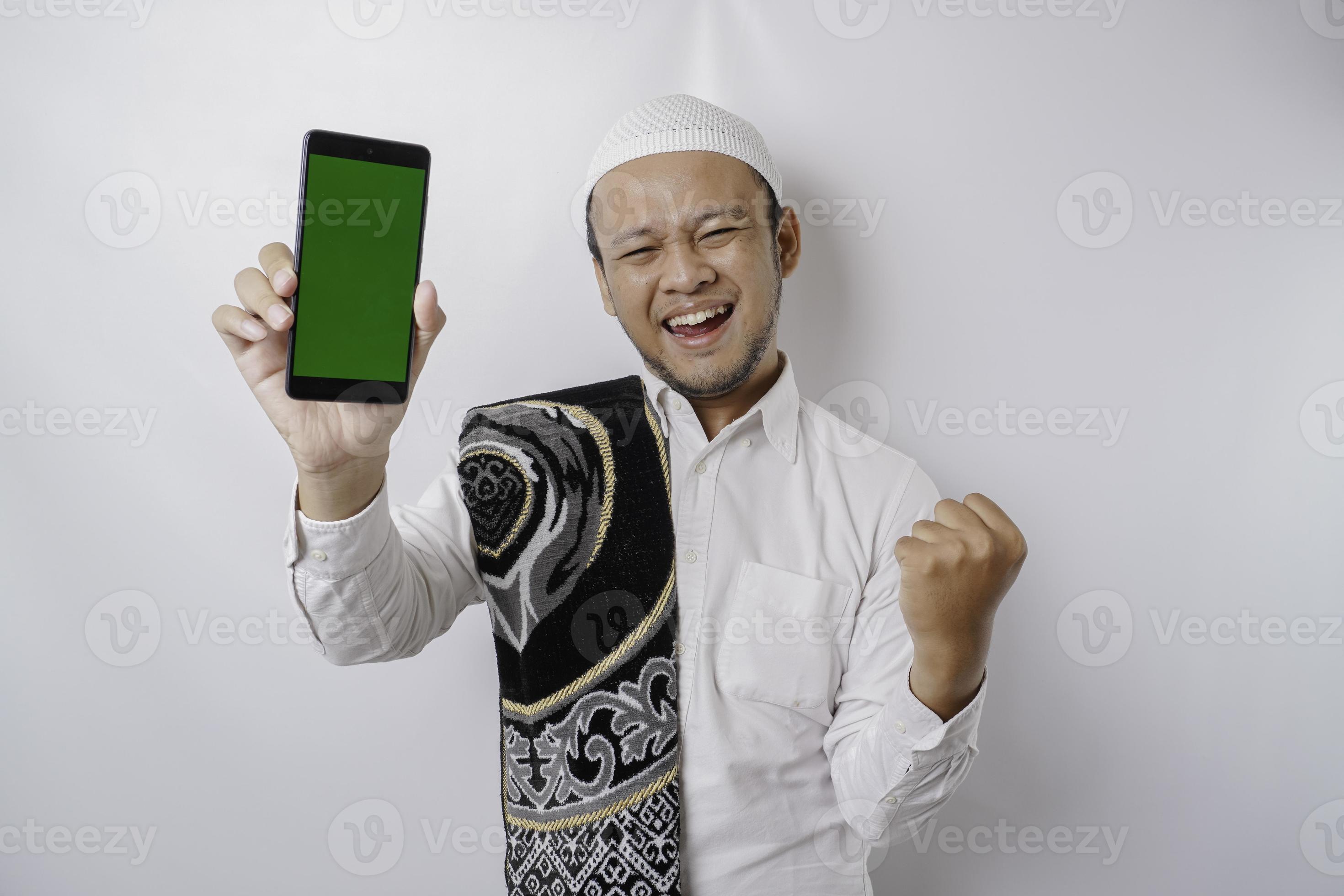 A happy young Asian Muslim man with a successful expression showing ...